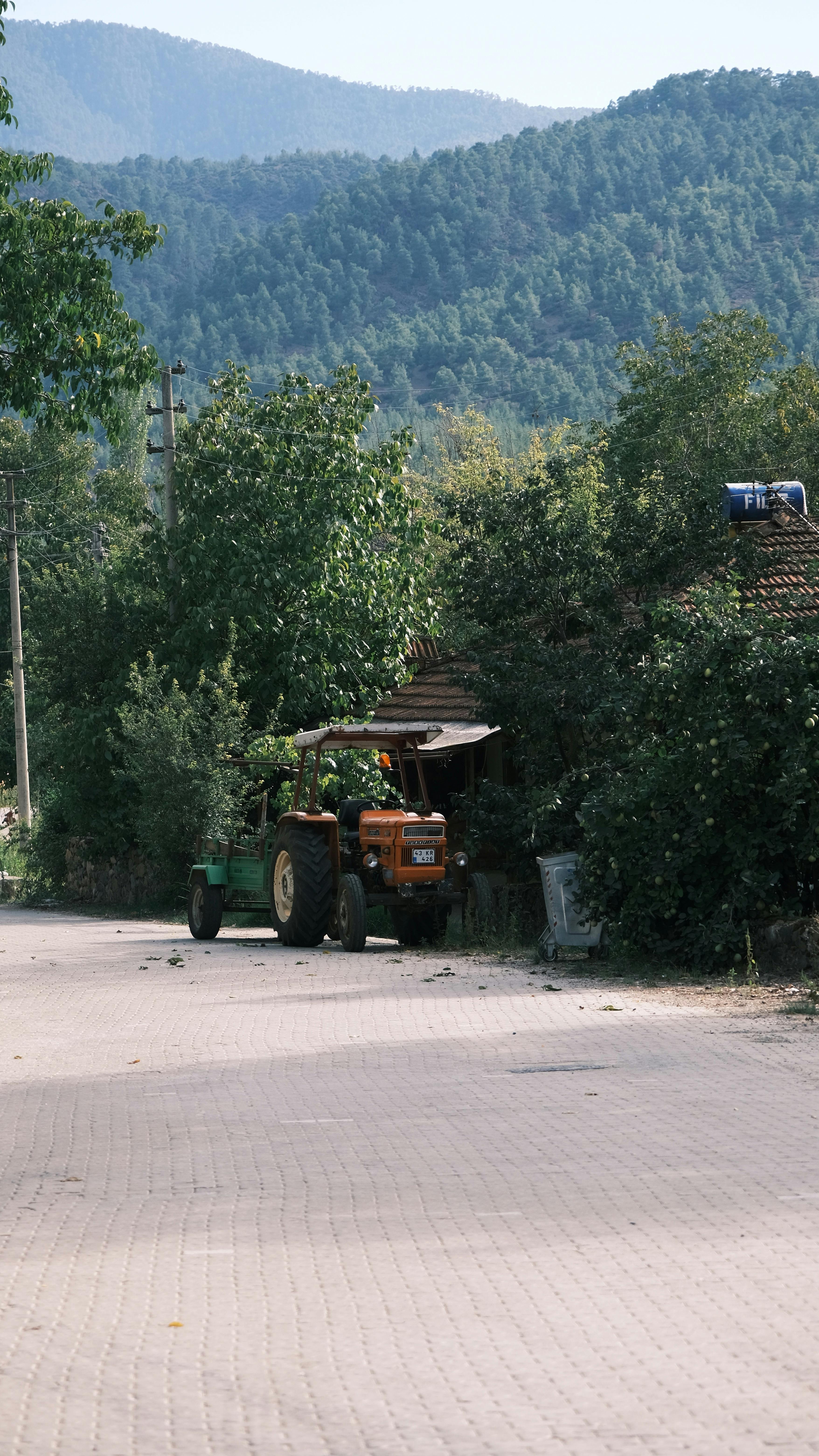 Rural Tractor Scene in Serene Mountain Setting · Free Stock Photo