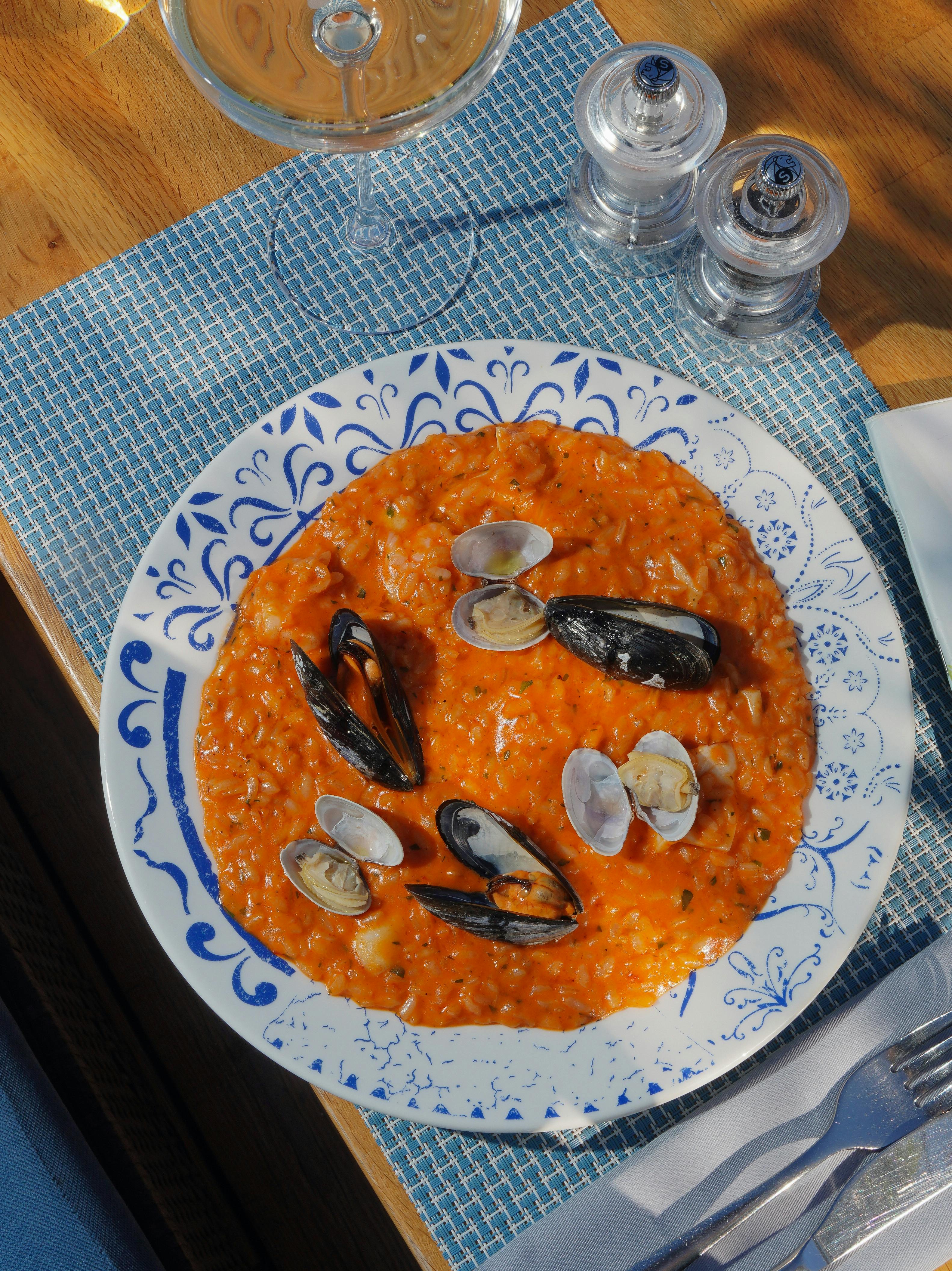 Delicious Seafood Risotto with Shellfish Plating · Free Stock Photo