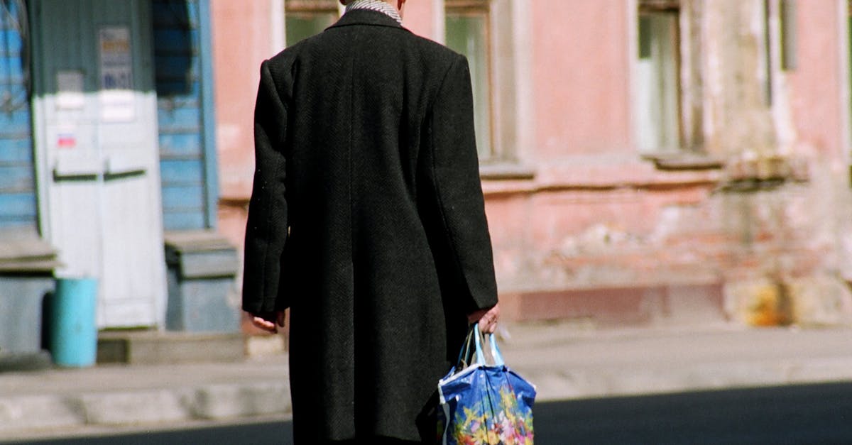Unrecognizable old male with package walking on street · Free Stock Photo Unrecognizable old male with package walking on street · Free Stock Photo