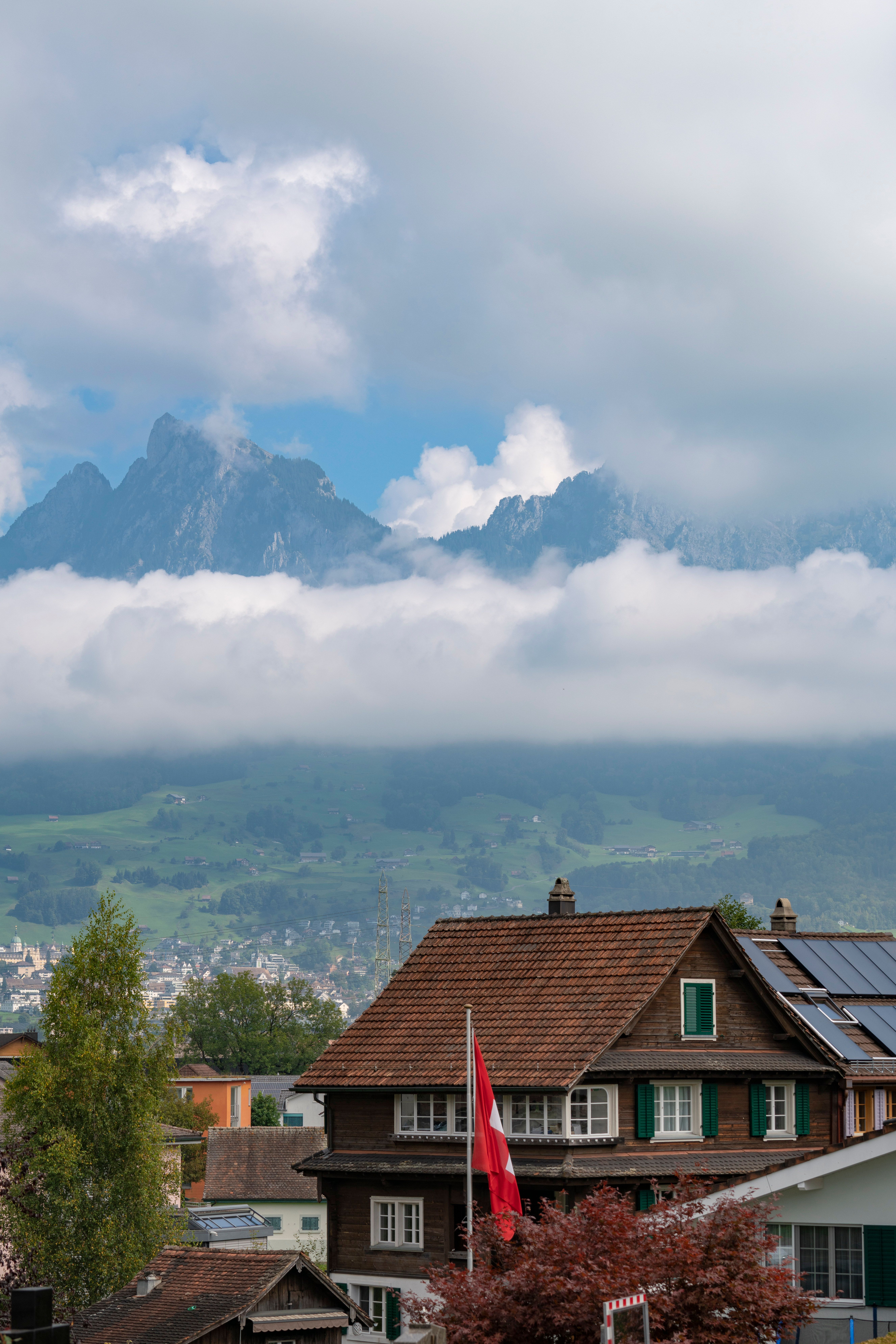 Charming Swiss Village with Mountain Backdrop · Free Stock Photo