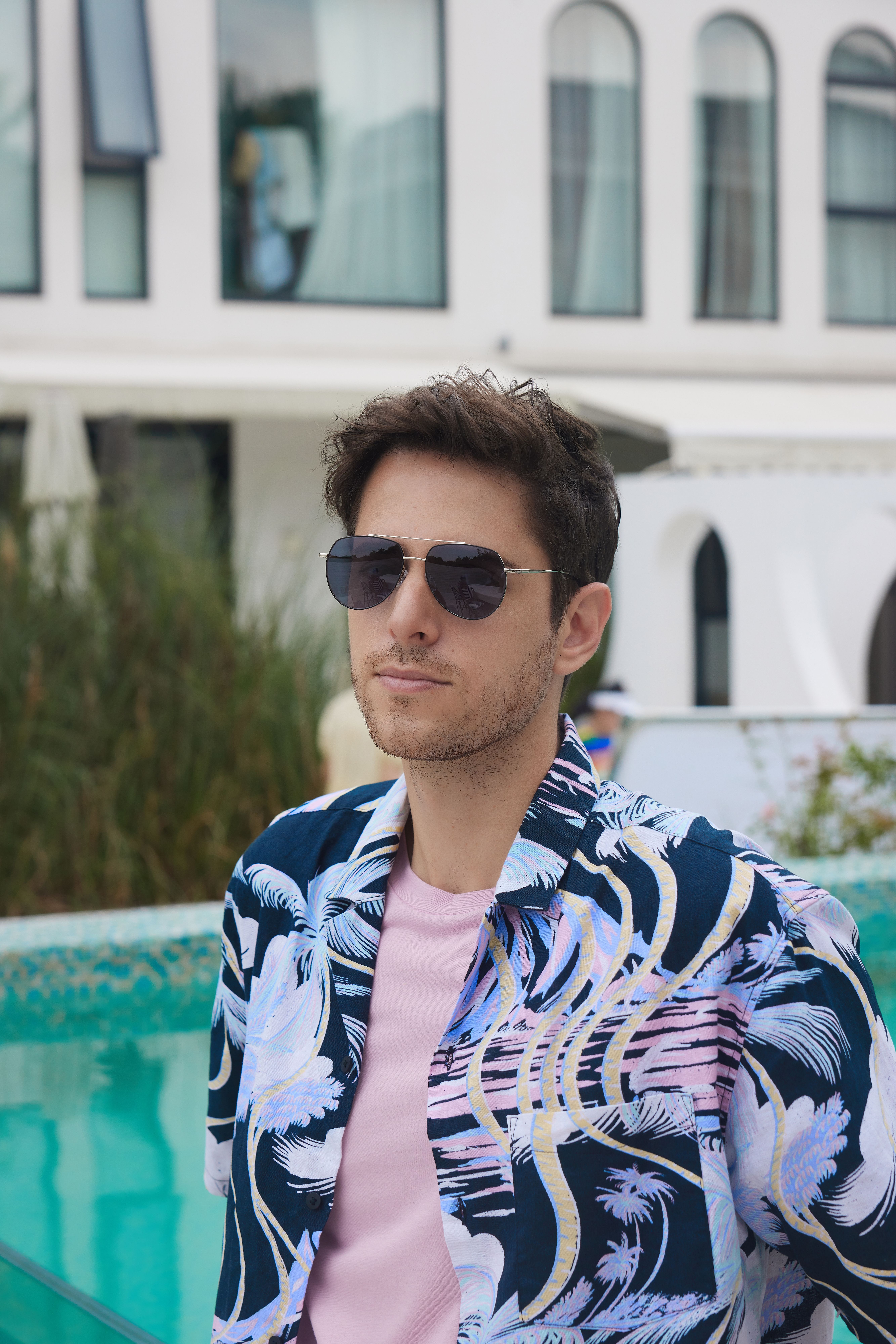 Stylish Man by Poolside in Vibrant Shirt · Free Stock Photo