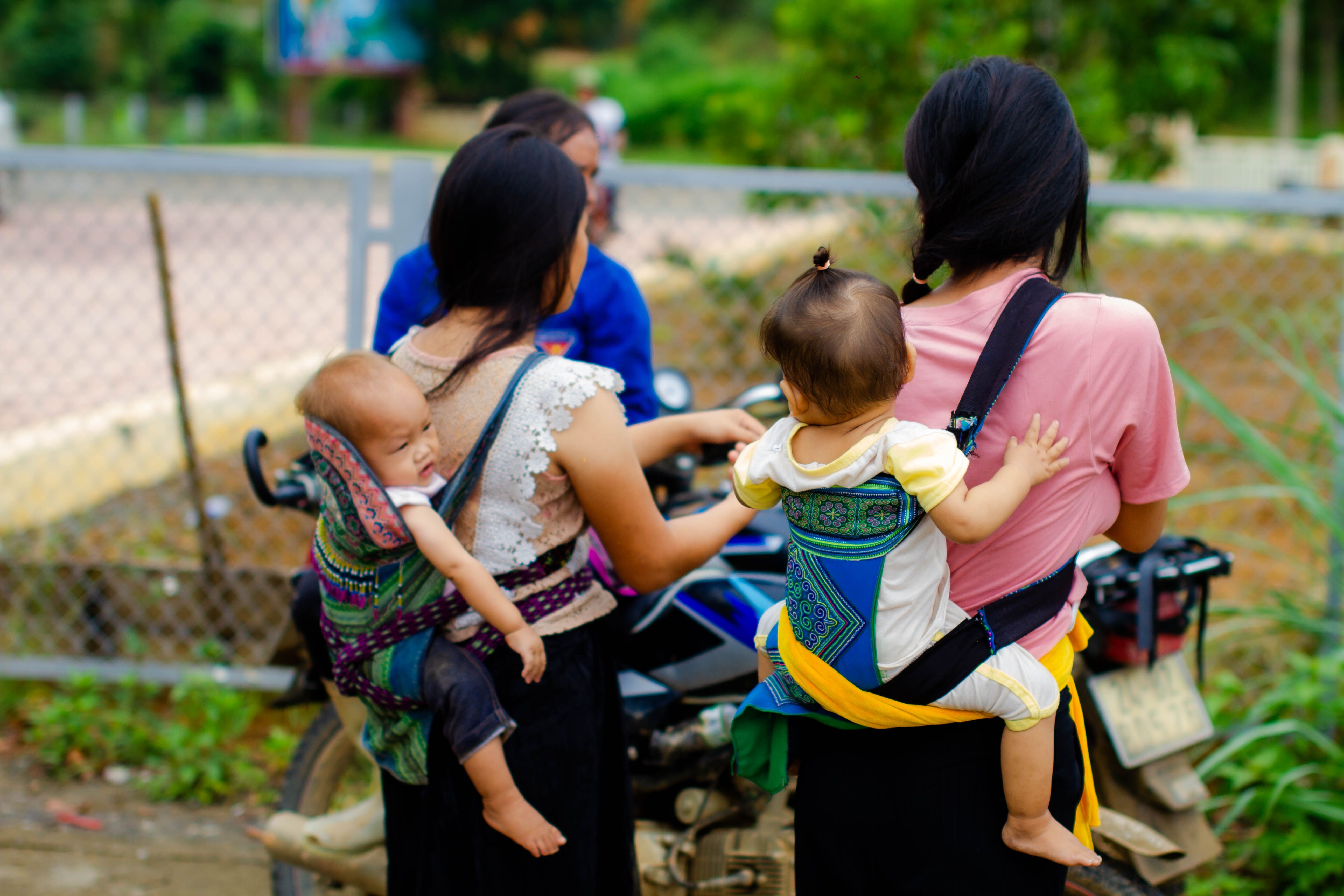 Mothers Carrying Babies in Traditional Carriers · Free Stock Photo