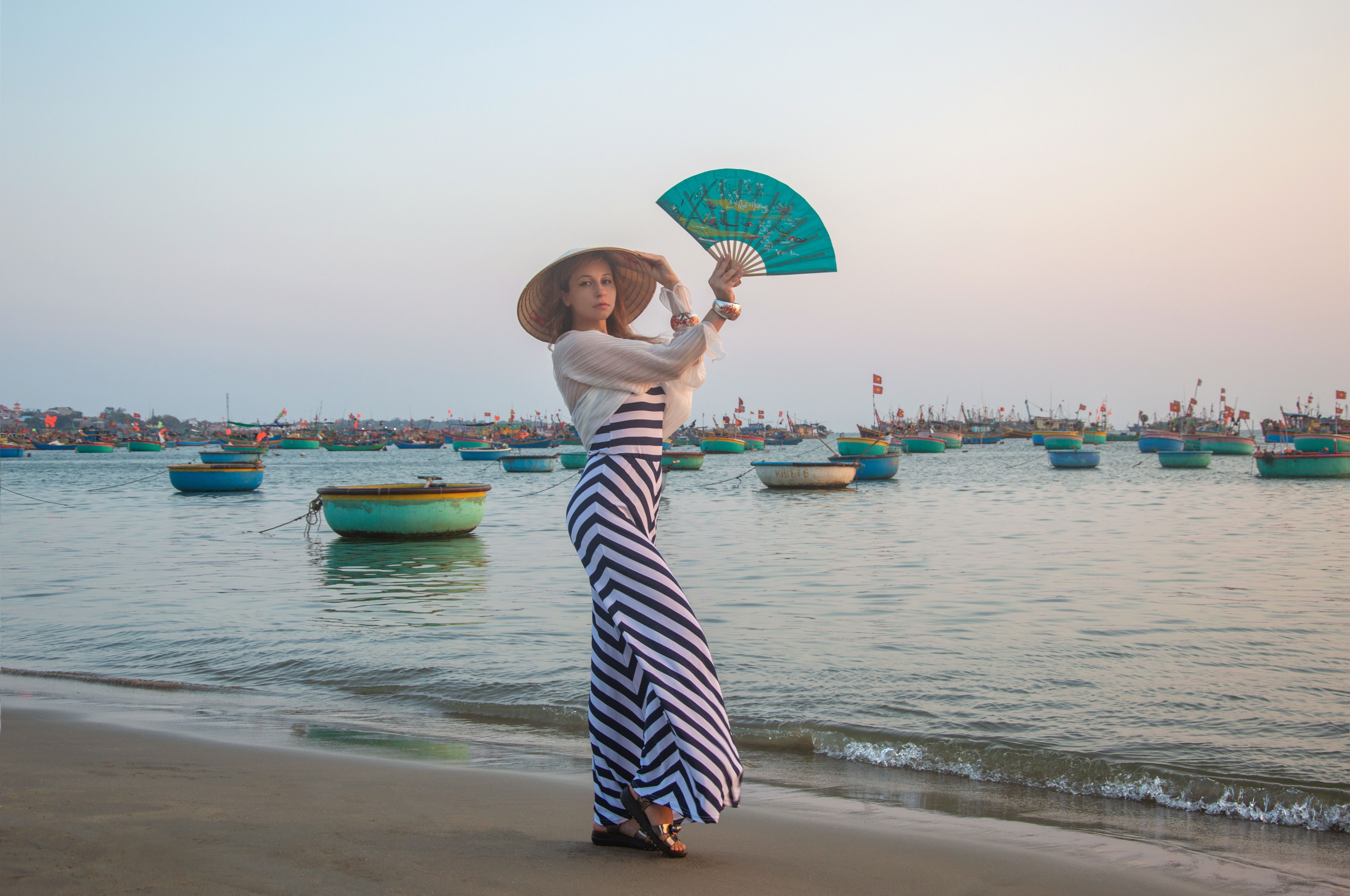 Woman with Fan on Beach at Sunset · Free Stock Photo