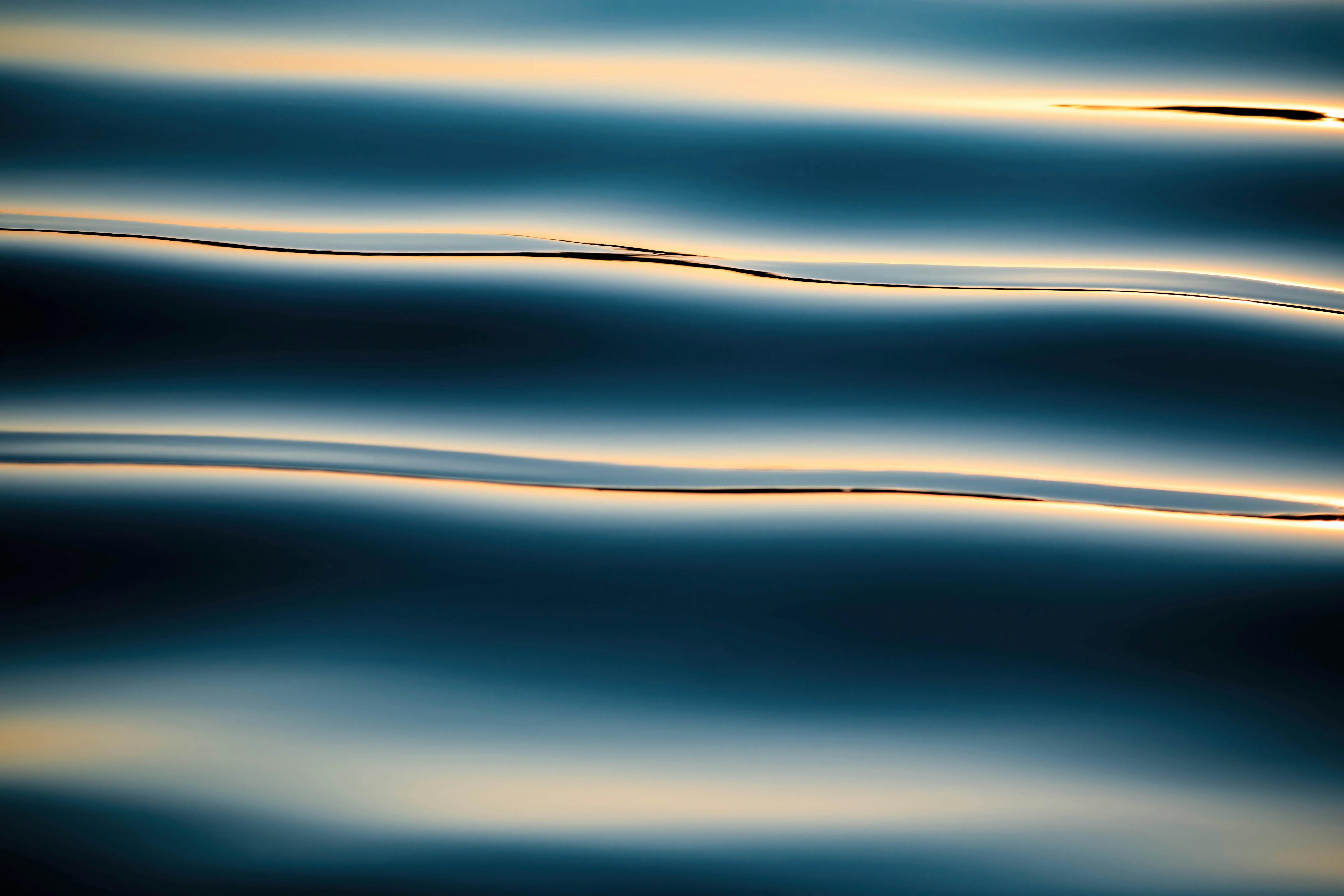 Serene Abstract Water Ripples in Golden Light · Free Stock Photo