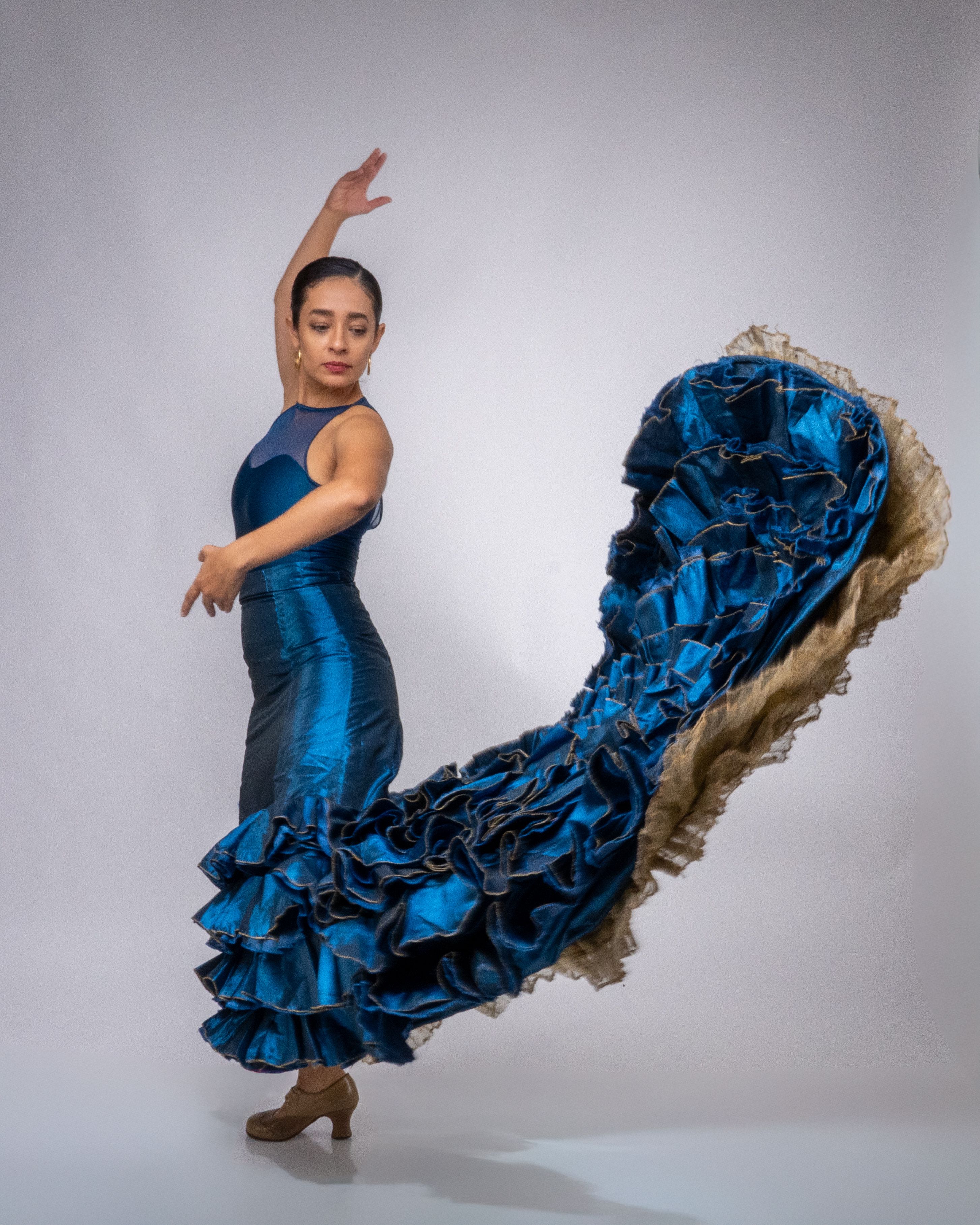 Dynamic Flamenco Dancer in Blue Dress Mid-Performance · Free Stock Photo