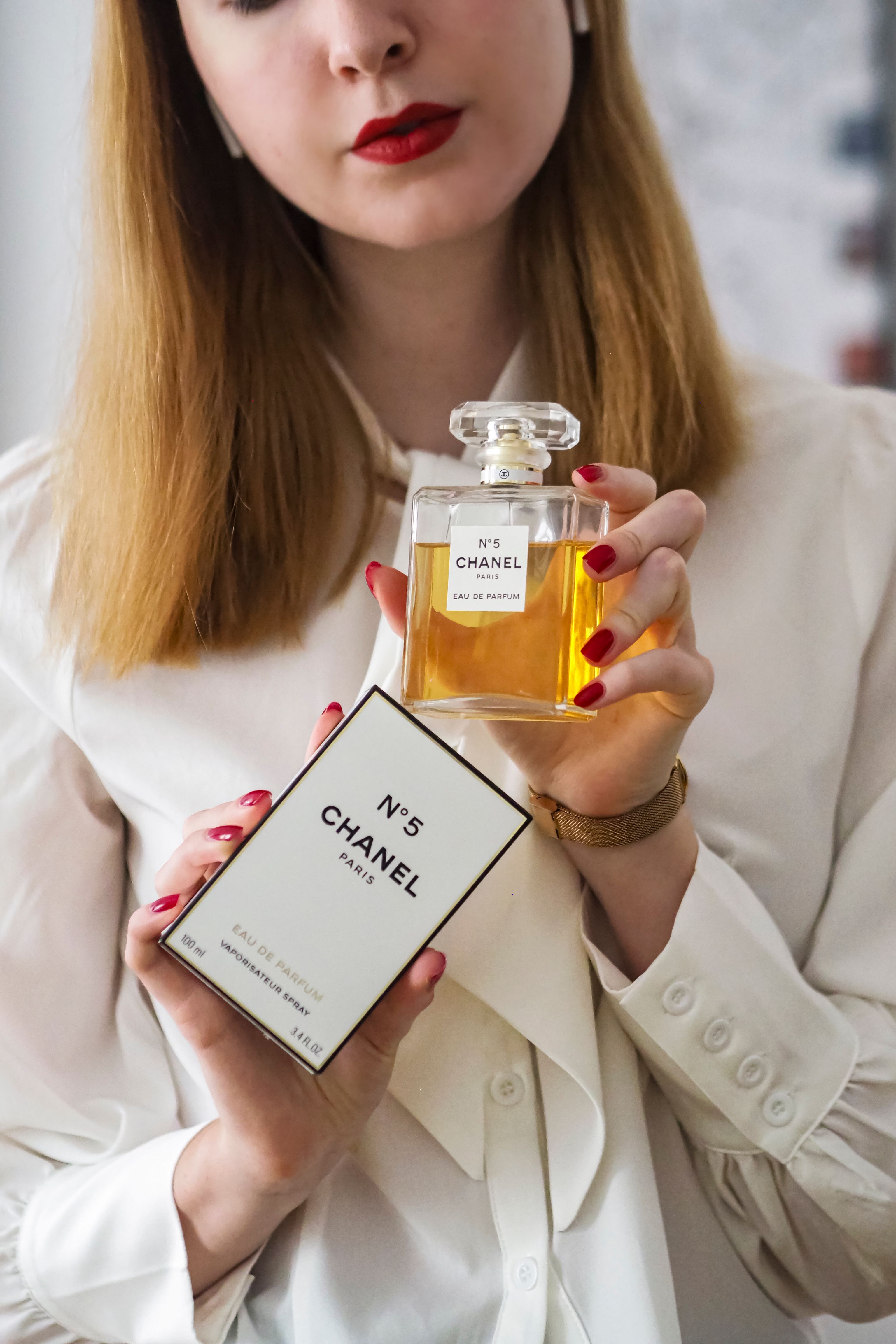 Woman Holding Chanel No.5 Perfume Bottle and Box · Free Stock Photo