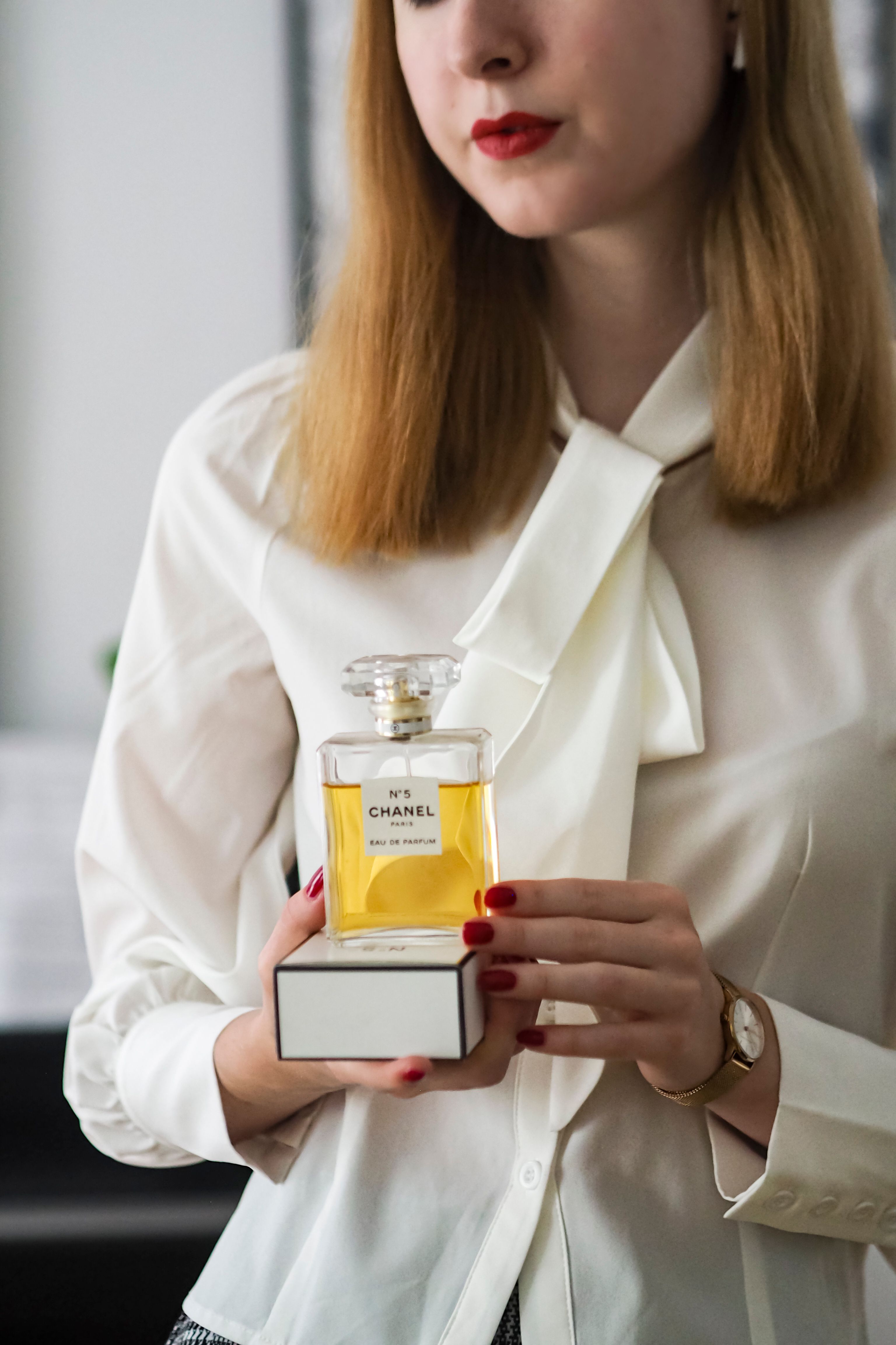 Elegant Woman Holding Luxury Perfume Bottle · Free Stock Photo