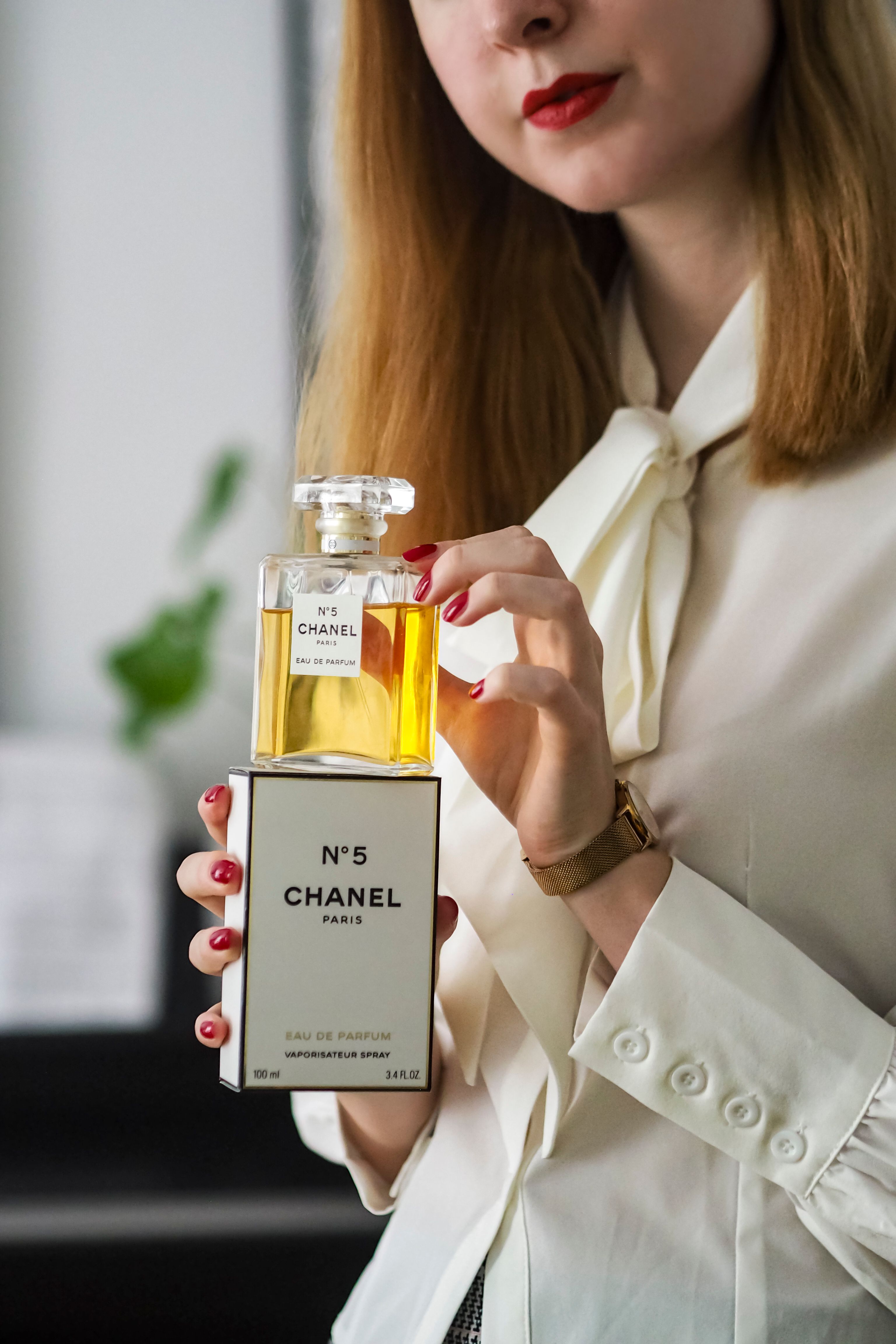 Elegant Woman Holding Chanel No. 5 Perfume Bottle · Free Stock Photo