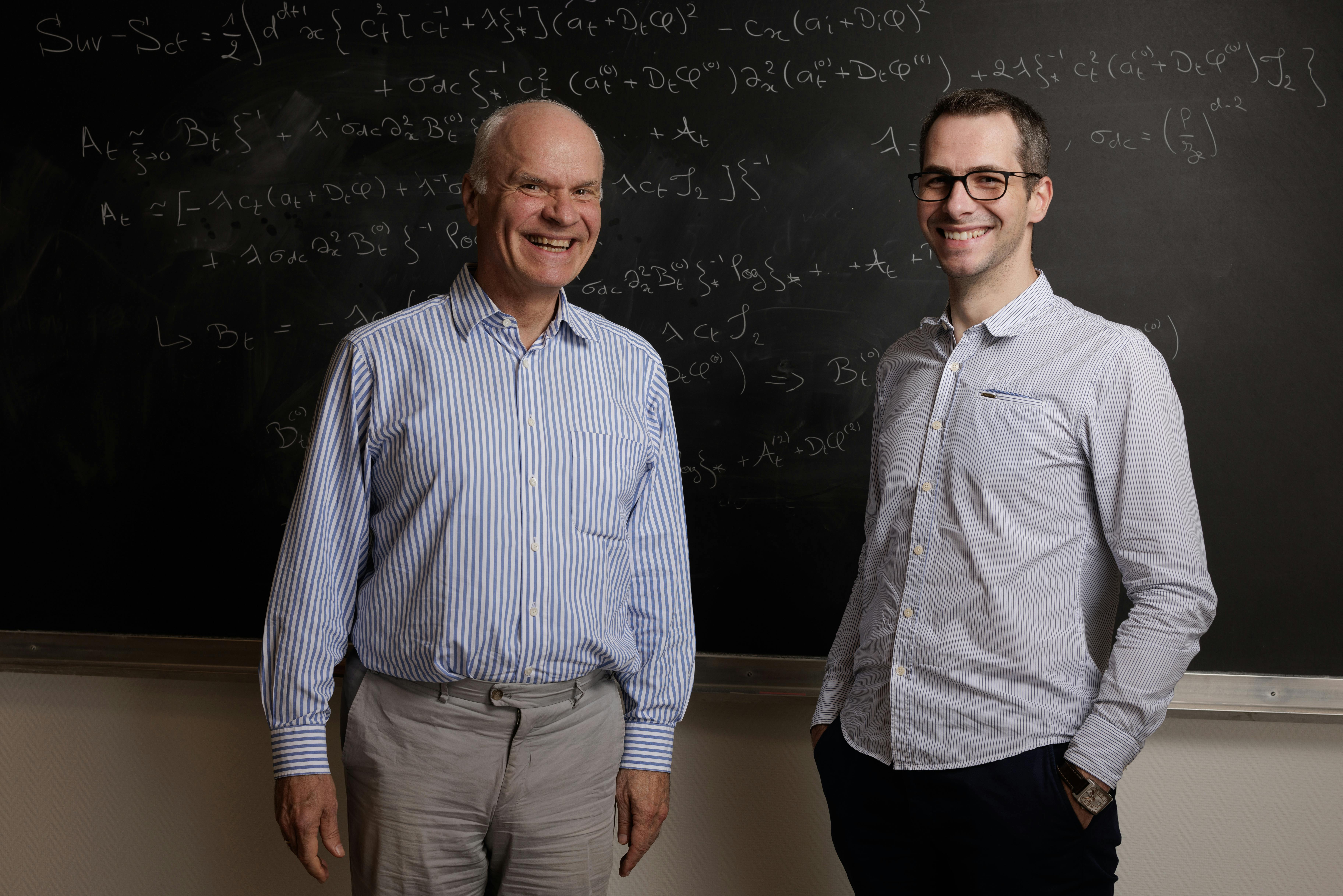 Professors Standing by Blackboard with Equations · Free Stock Photo