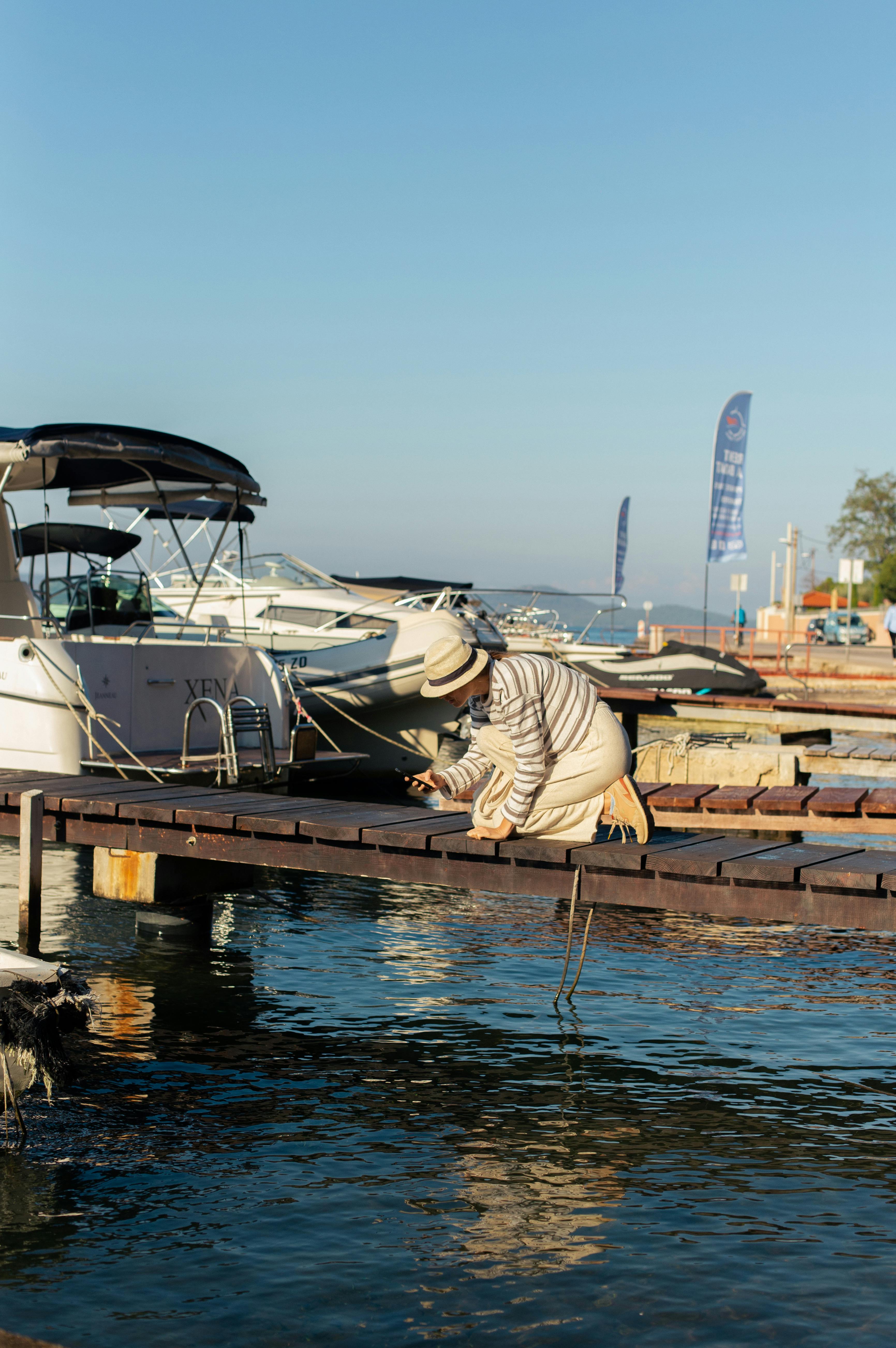 Person Sitting on Dock in Zadar Harbor · Free Stock Photo