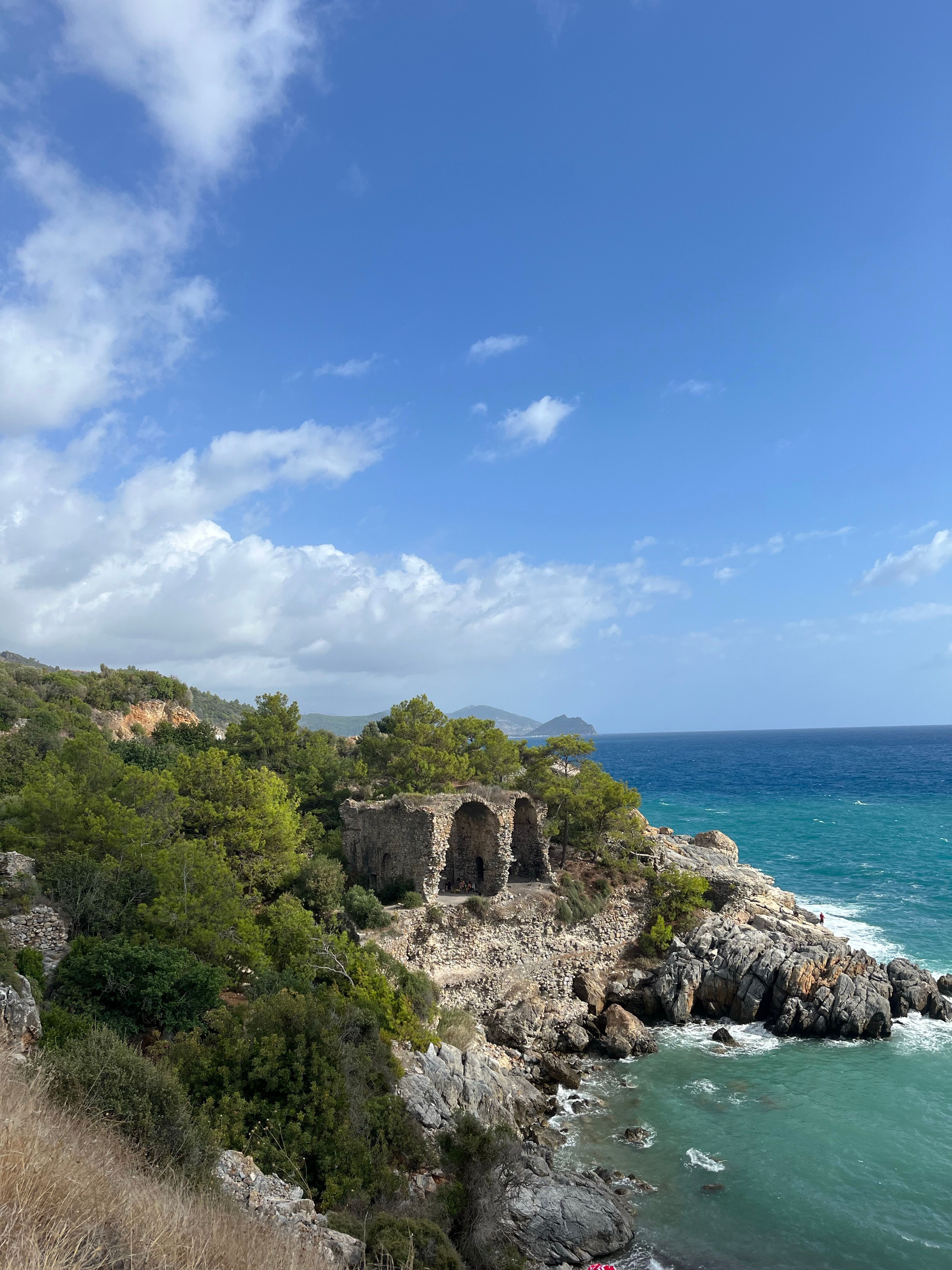 Historic Coastal Ruins by the Sea with Vibrant Sky · Free Stock Photo