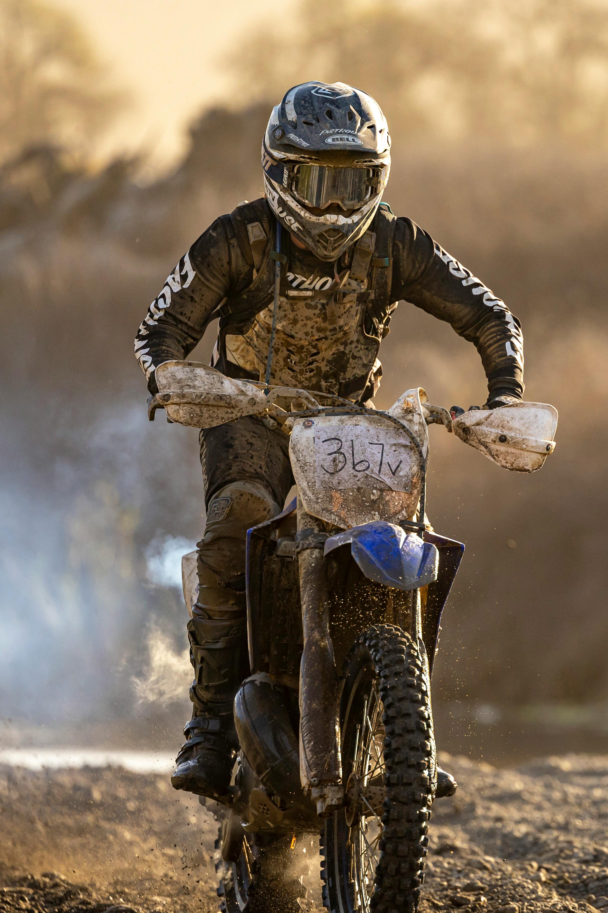 Dirt Biker Racing Across Muddy Terrain · Free Stock Photo