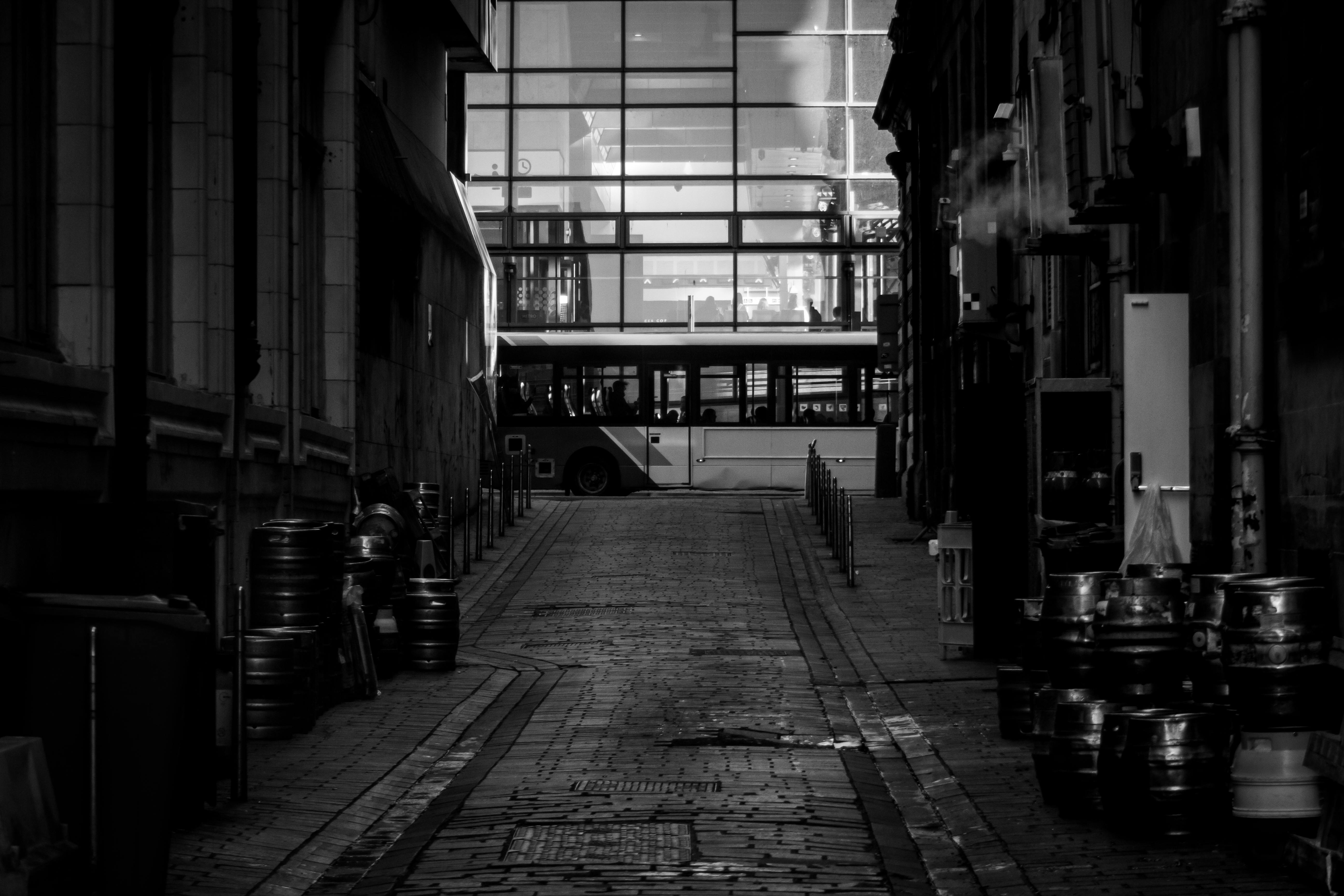 Urban Alleyway View with Bus and Reflections · Free Stock Photo