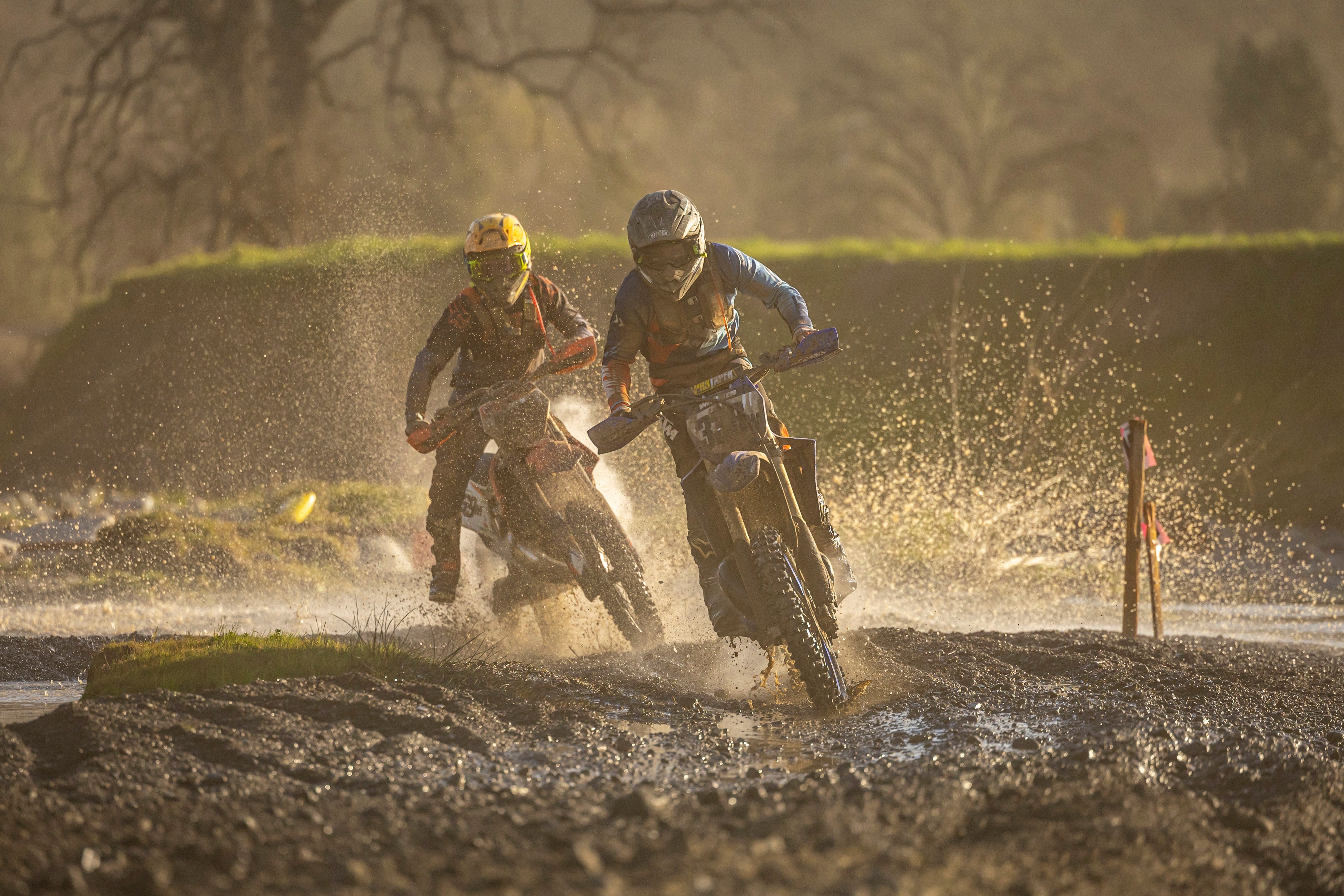 Exciting Off-Road Dirt Bike Race in Muddy Terrain · Free Stock Photo