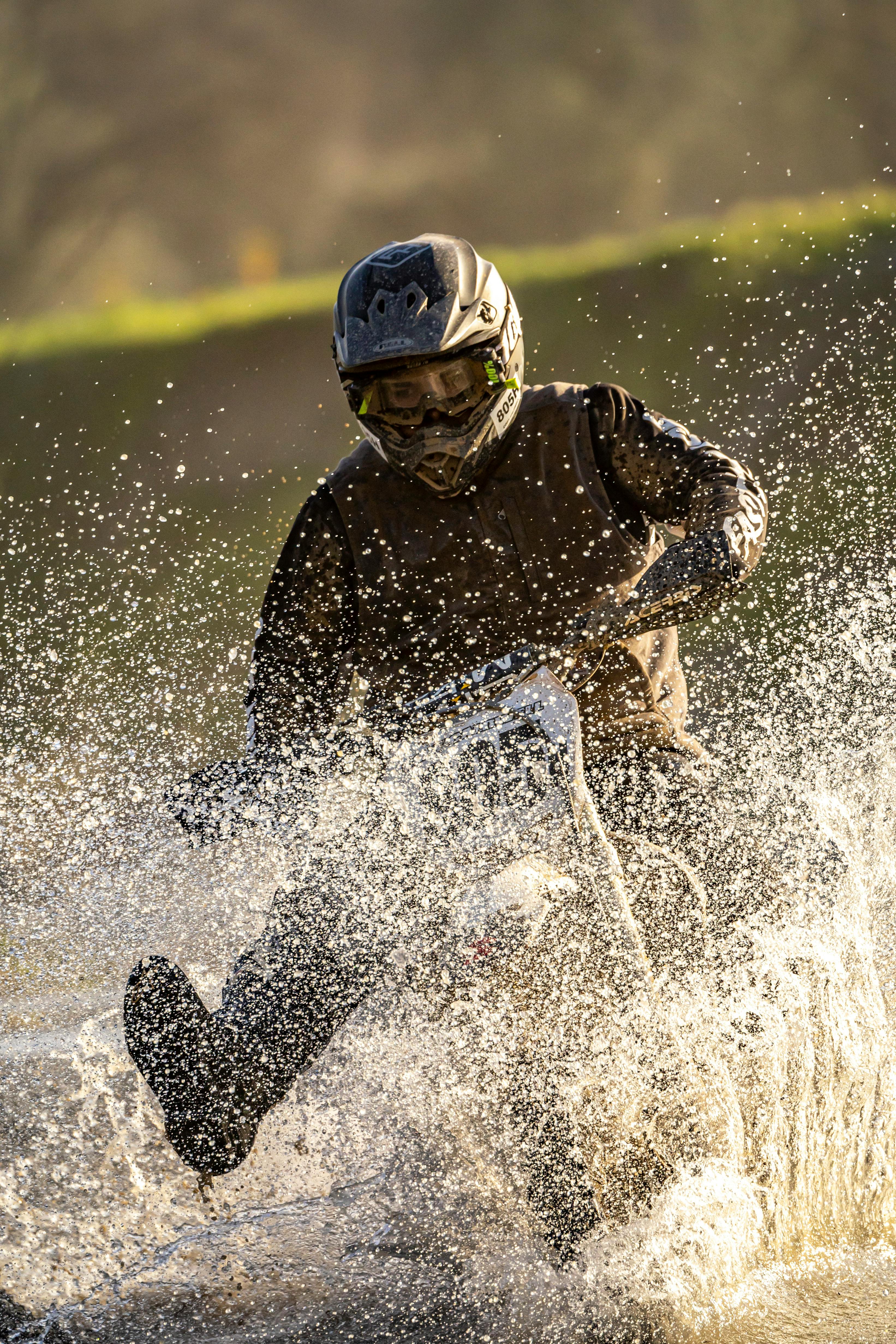 Off-Road Biker Splashes Through Water Adventure · Free Stock Photo