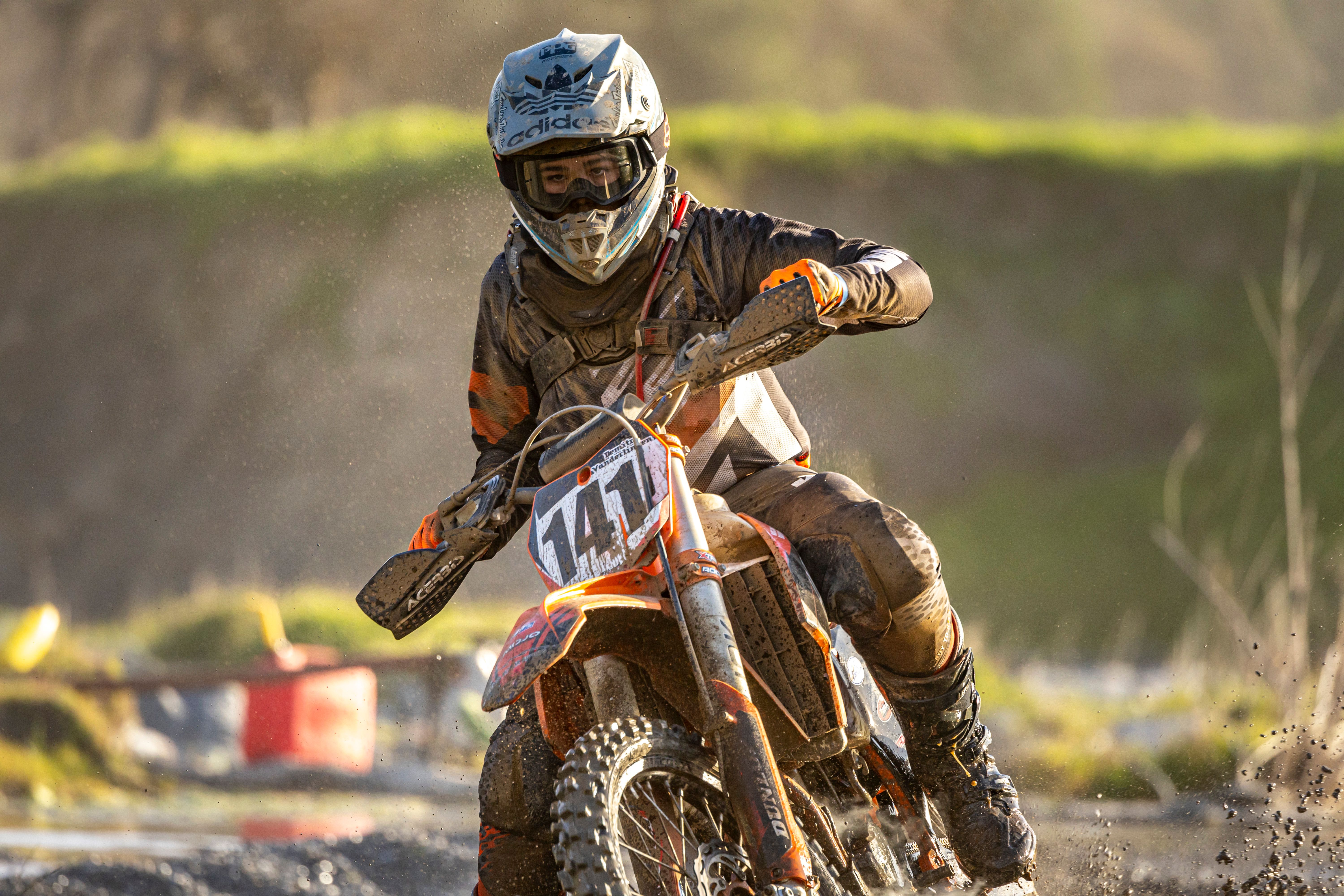 Dirt Bike Racer in Action on Muddy Track · Free Stock Photo