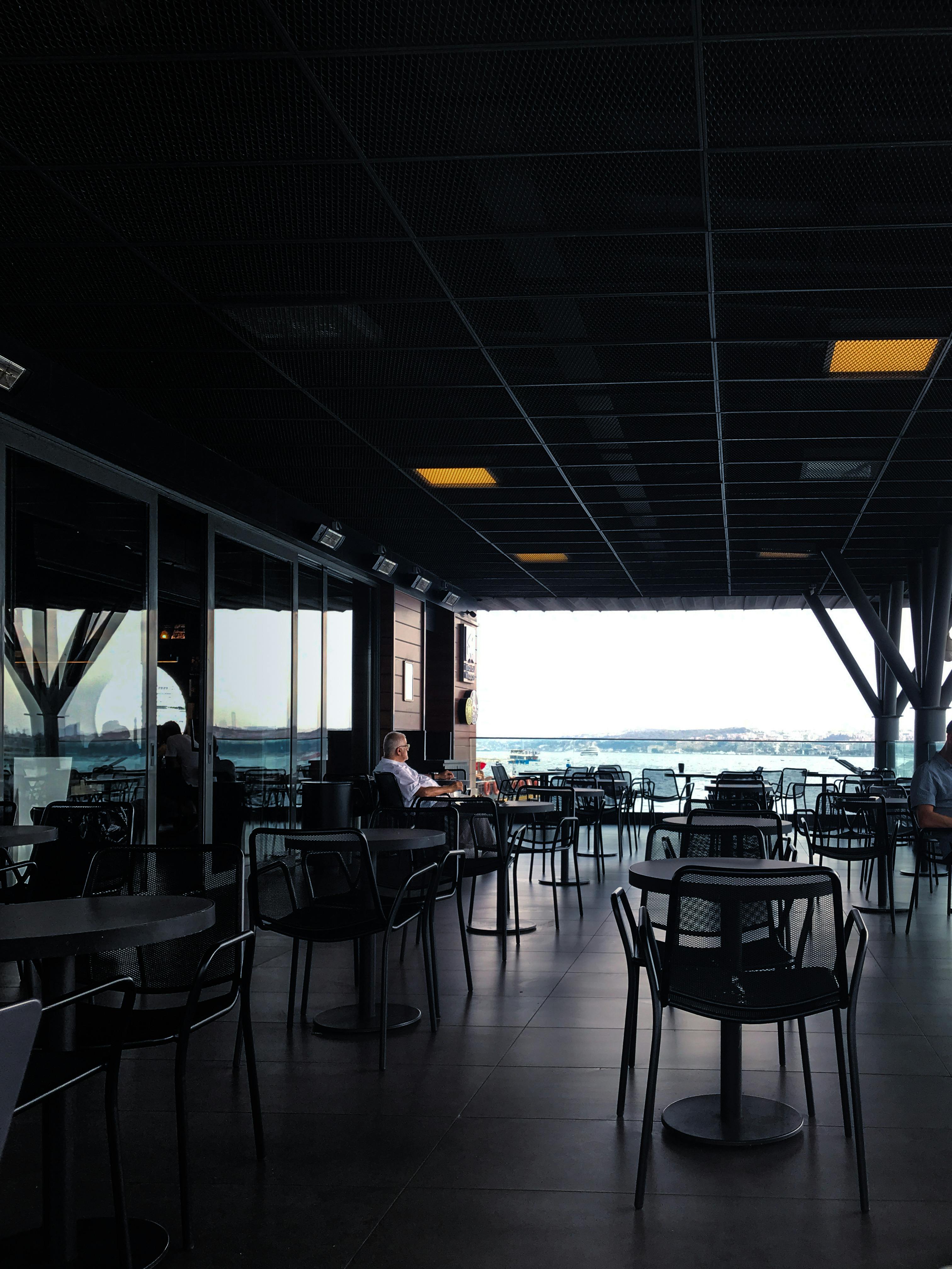 Modern Outdoor Cafe Overlooking Scenic Water · Free Stock Photo