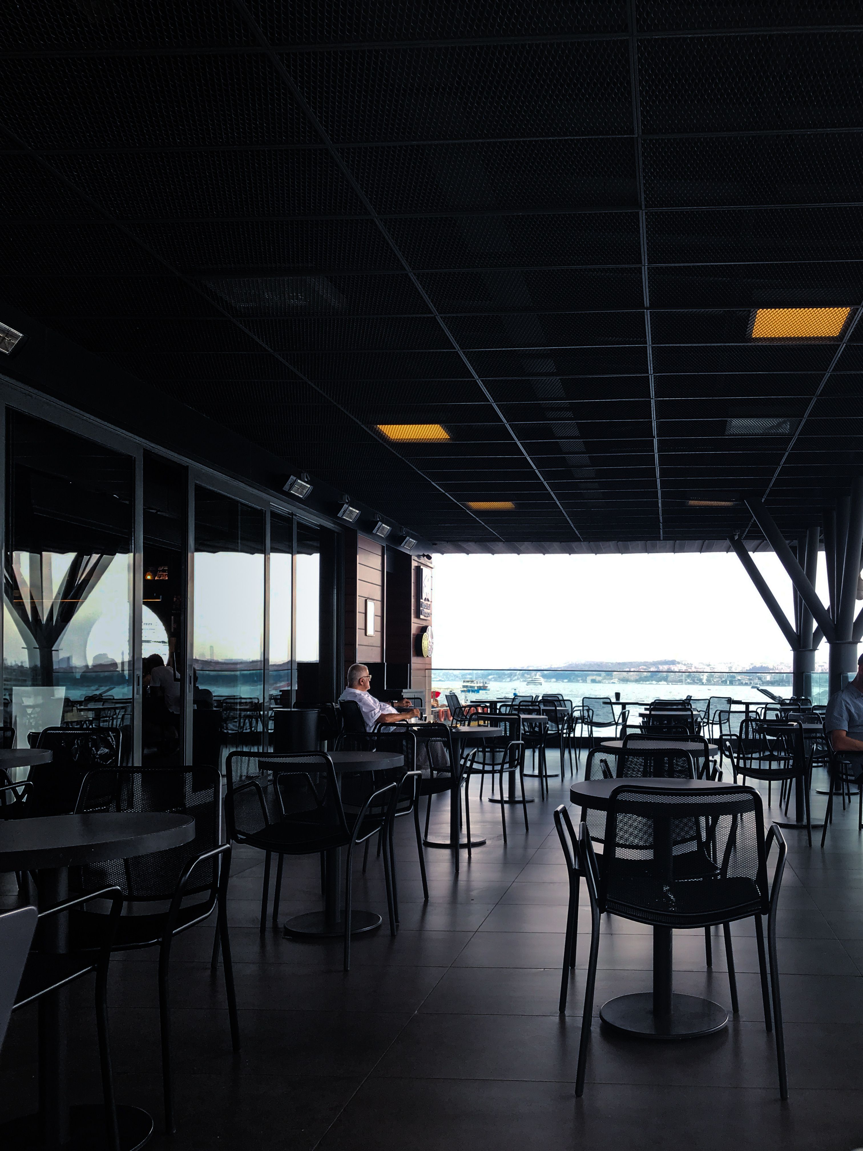 Modern Outdoor Cafe Overlooking Scenic Water · Free Stock Photo