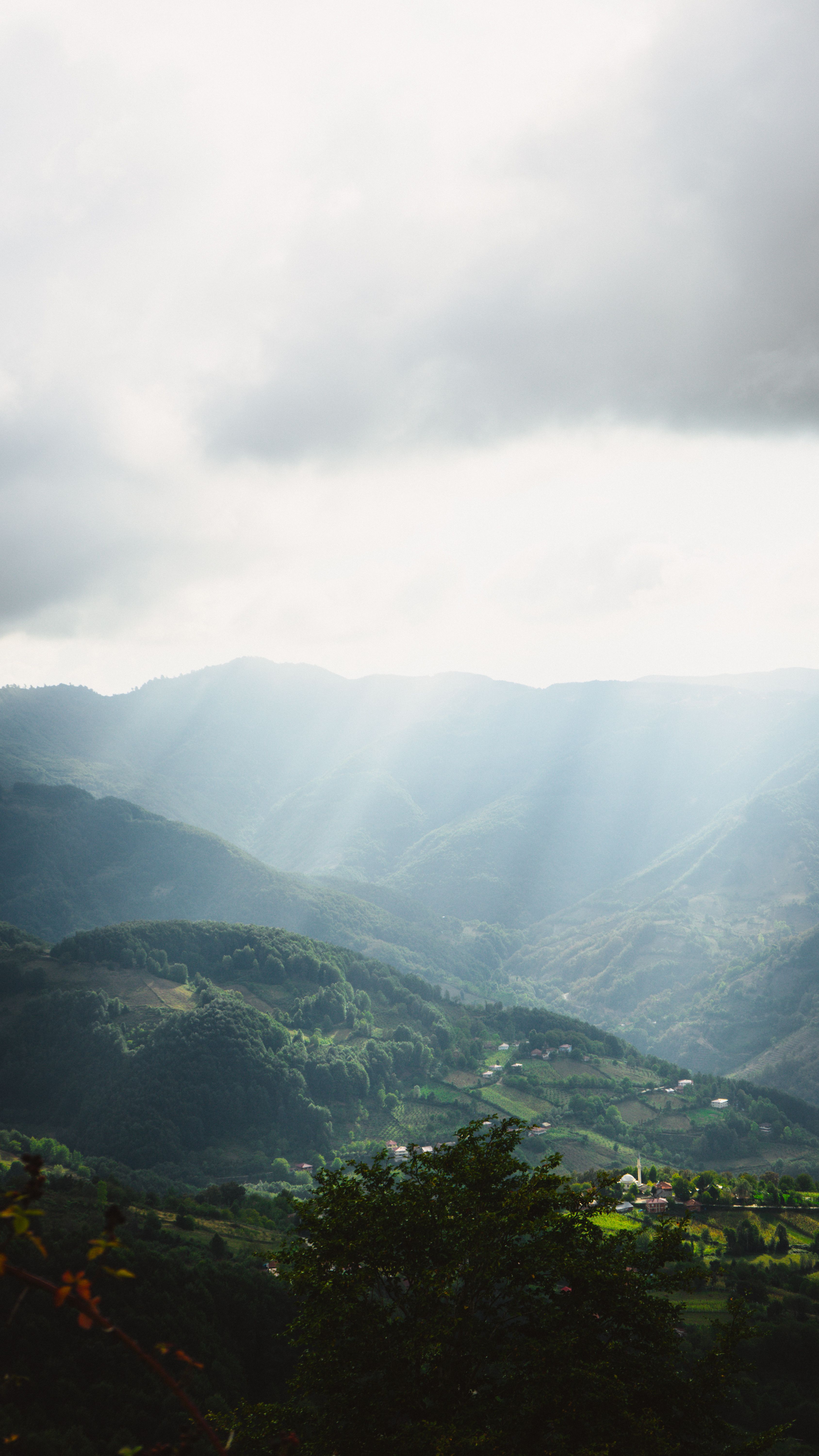 Scenic View of Sun Rays Over Mountain Valley · Free Stock Photo