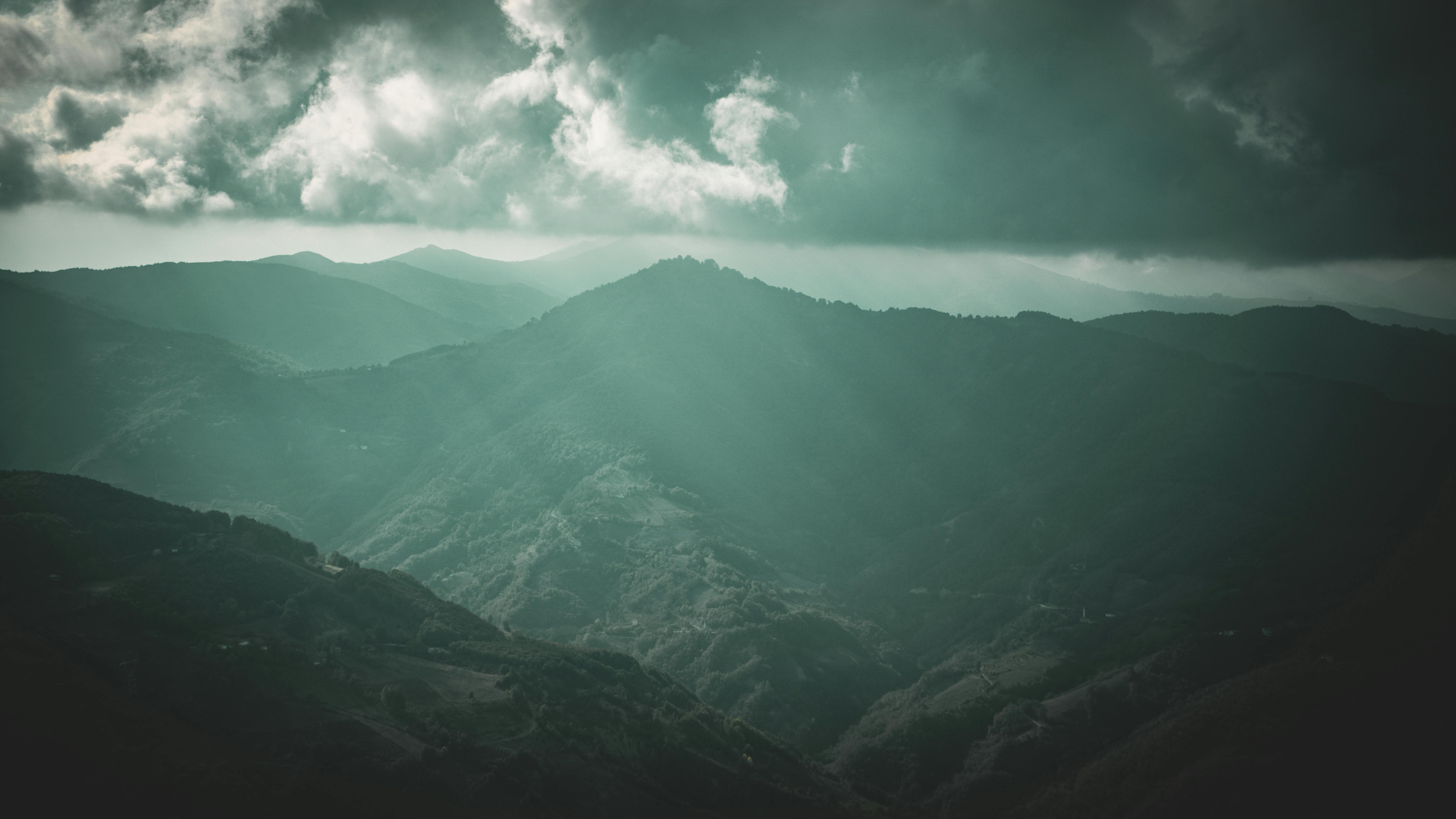 Dramatic Mountain Landscape Under Stormy Skies · Free Stock Photo