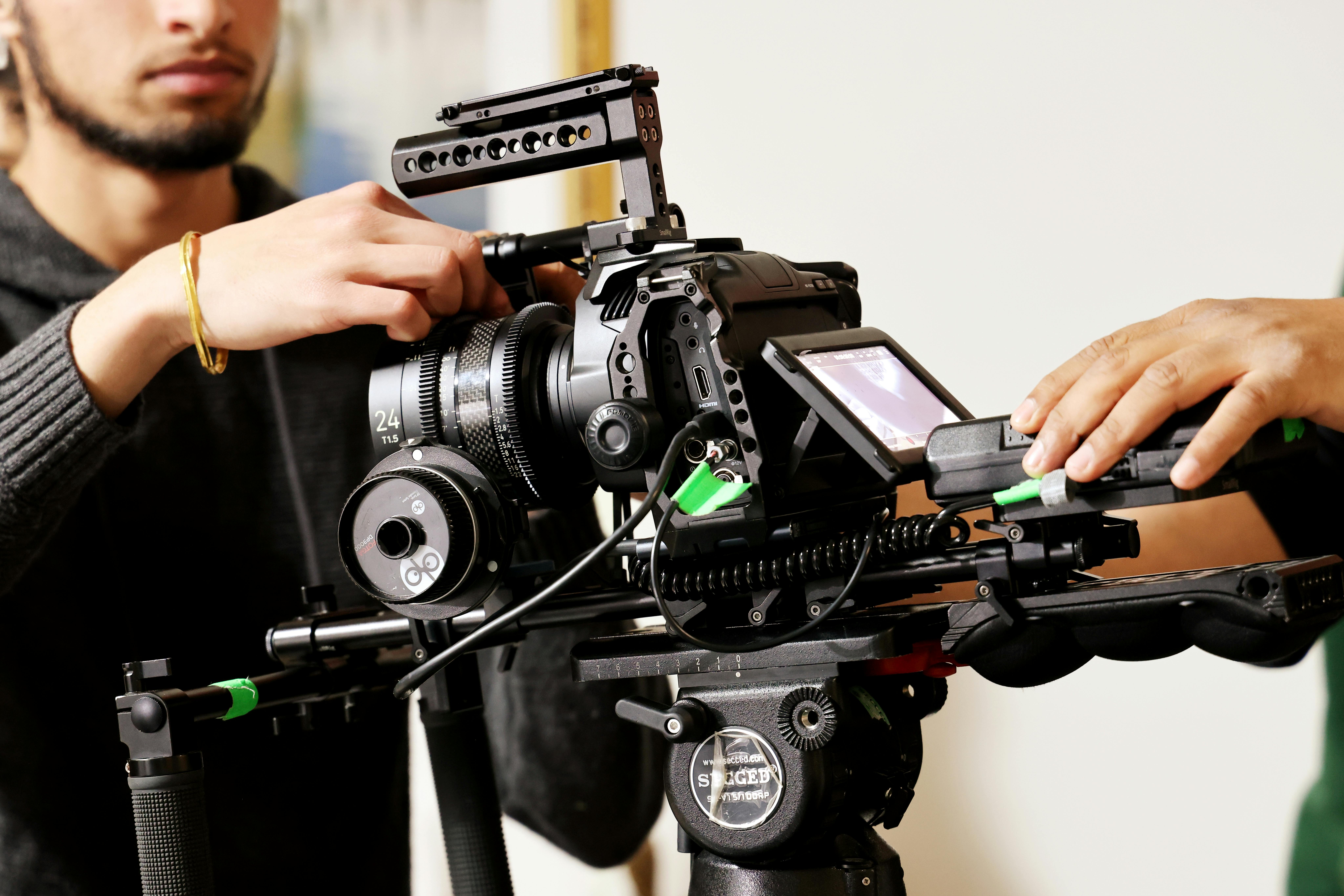 Professional Videographers Adjusting Camera Setup · Free Stock Photo