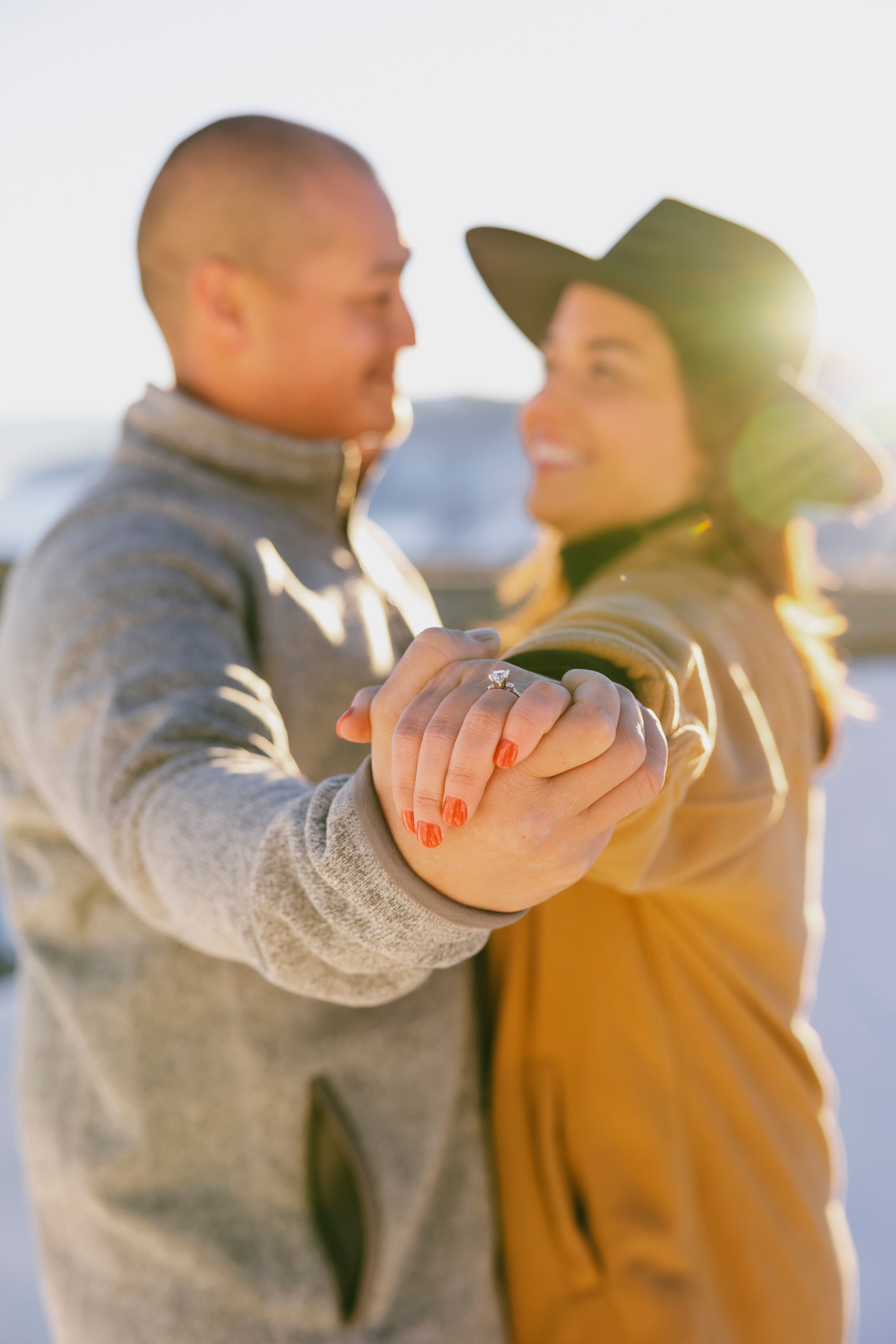 Romantic Engagement Couple Holding Hands Outdoors · Free Stock Photo