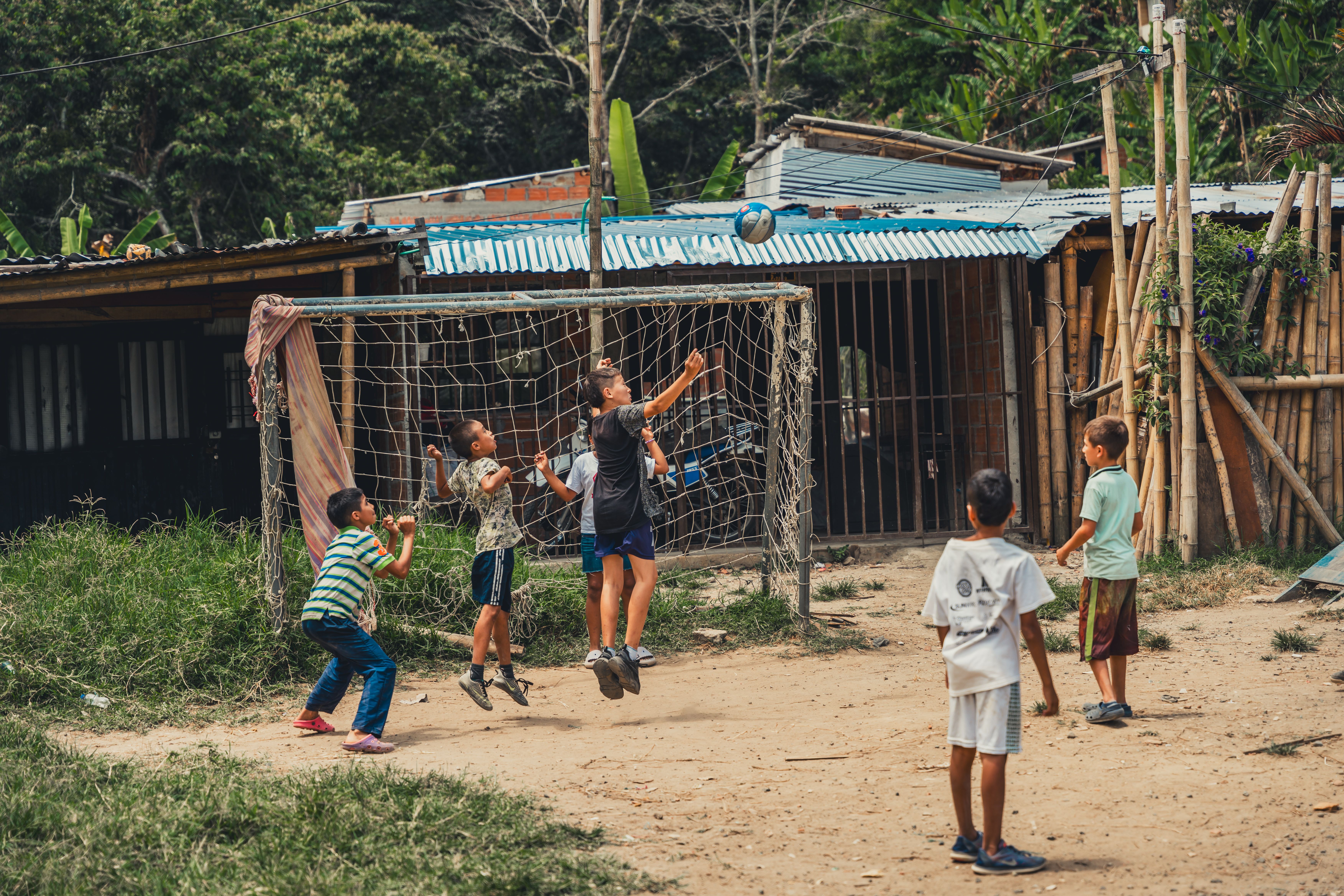 Children Playing Soccer in Rural Setting · Free Stock Photo