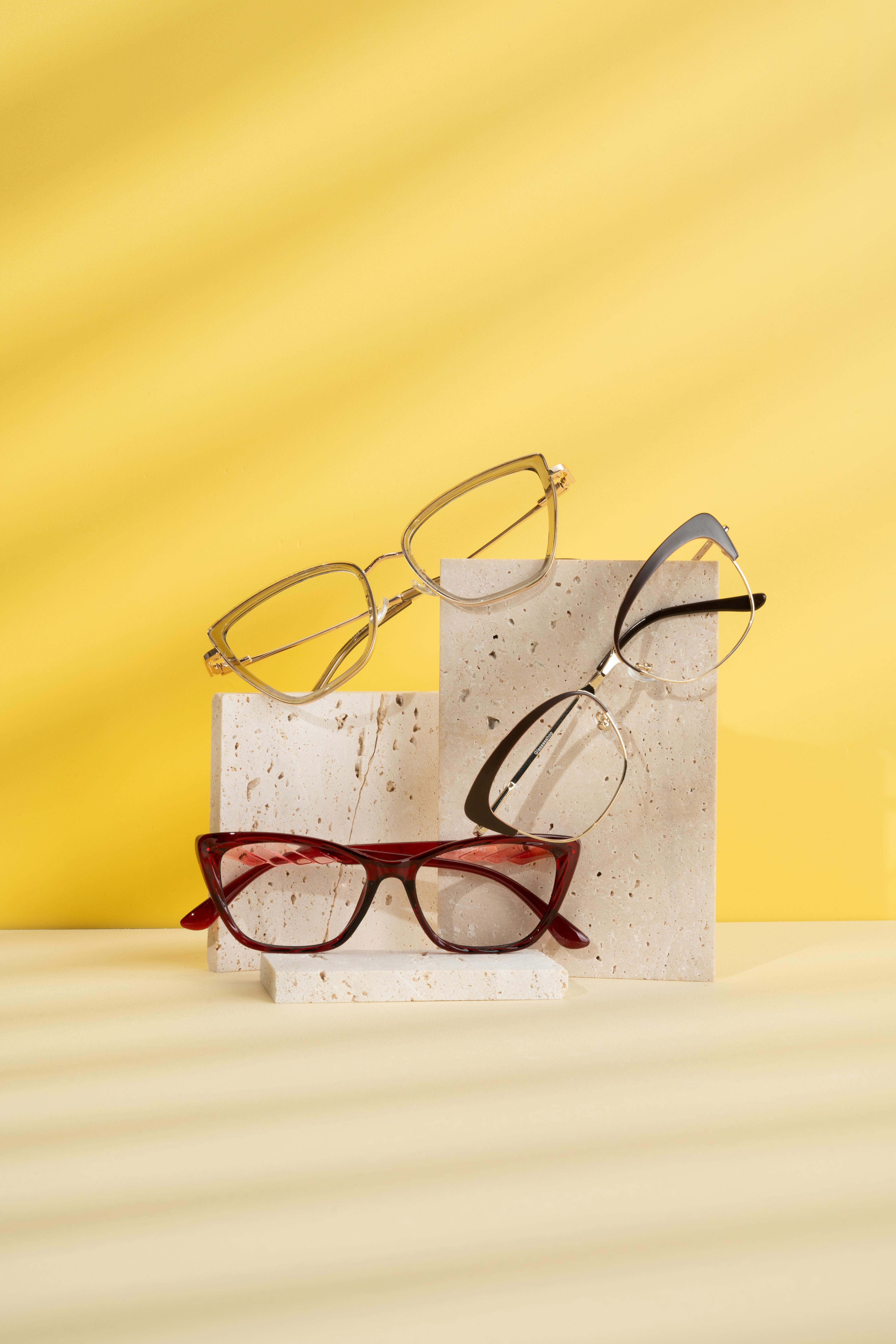Modern Eyewear Display Against Yellow Background · Free Stock Photo