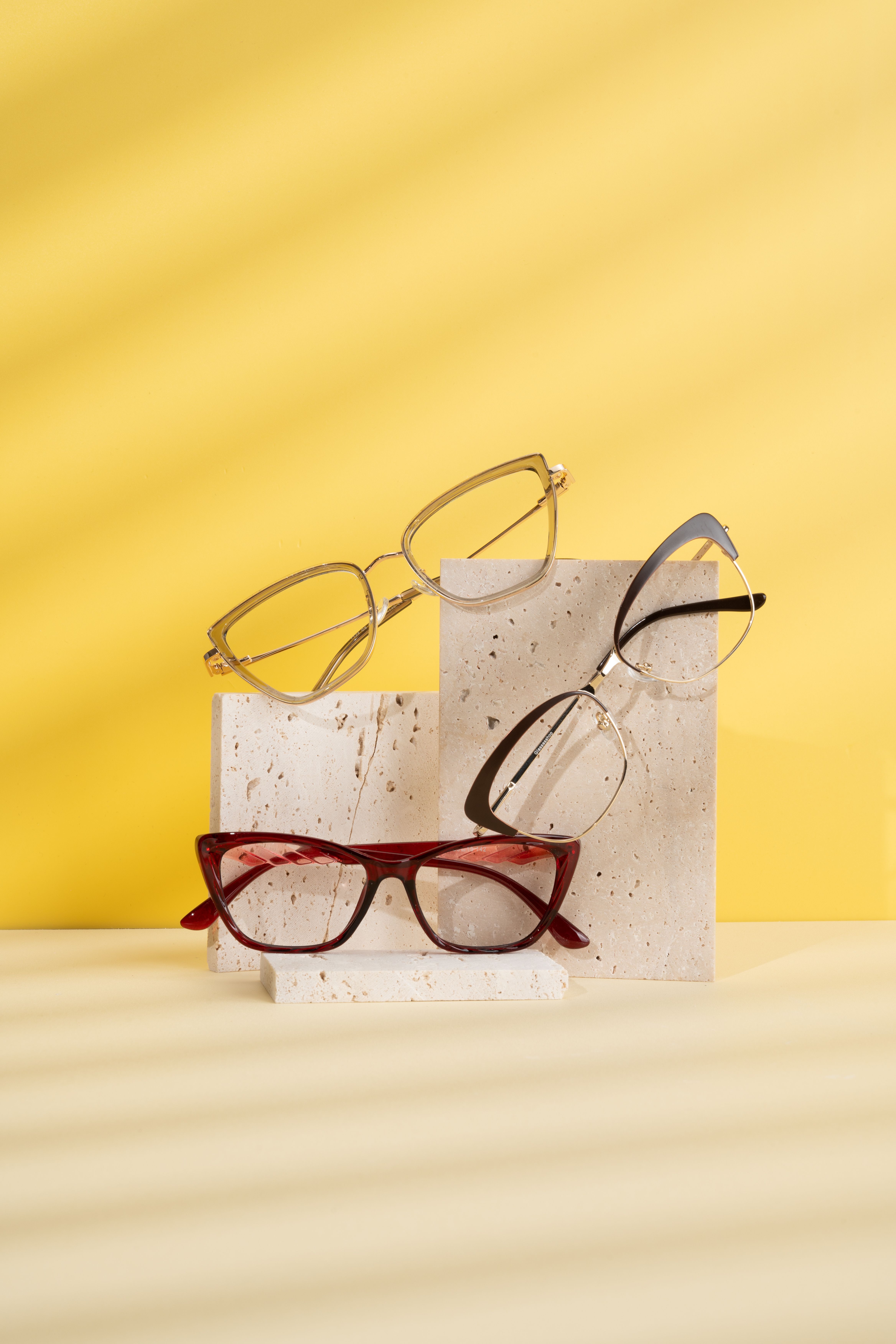 Modern Eyewear Display Against Yellow Background · Free Stock Photo