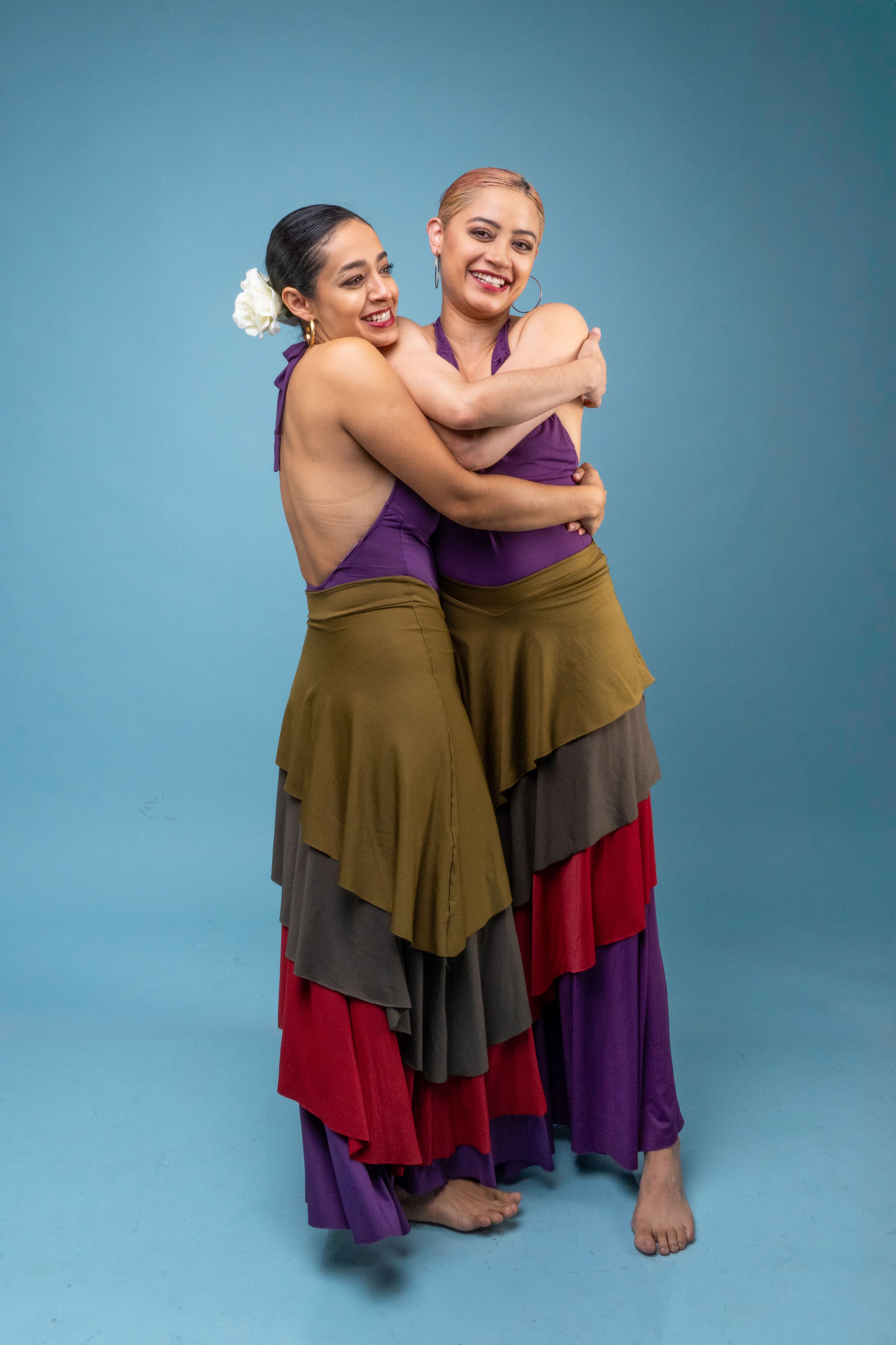 Two Female Dancers Embracing in Colorful Dresses · Free Stock Photo