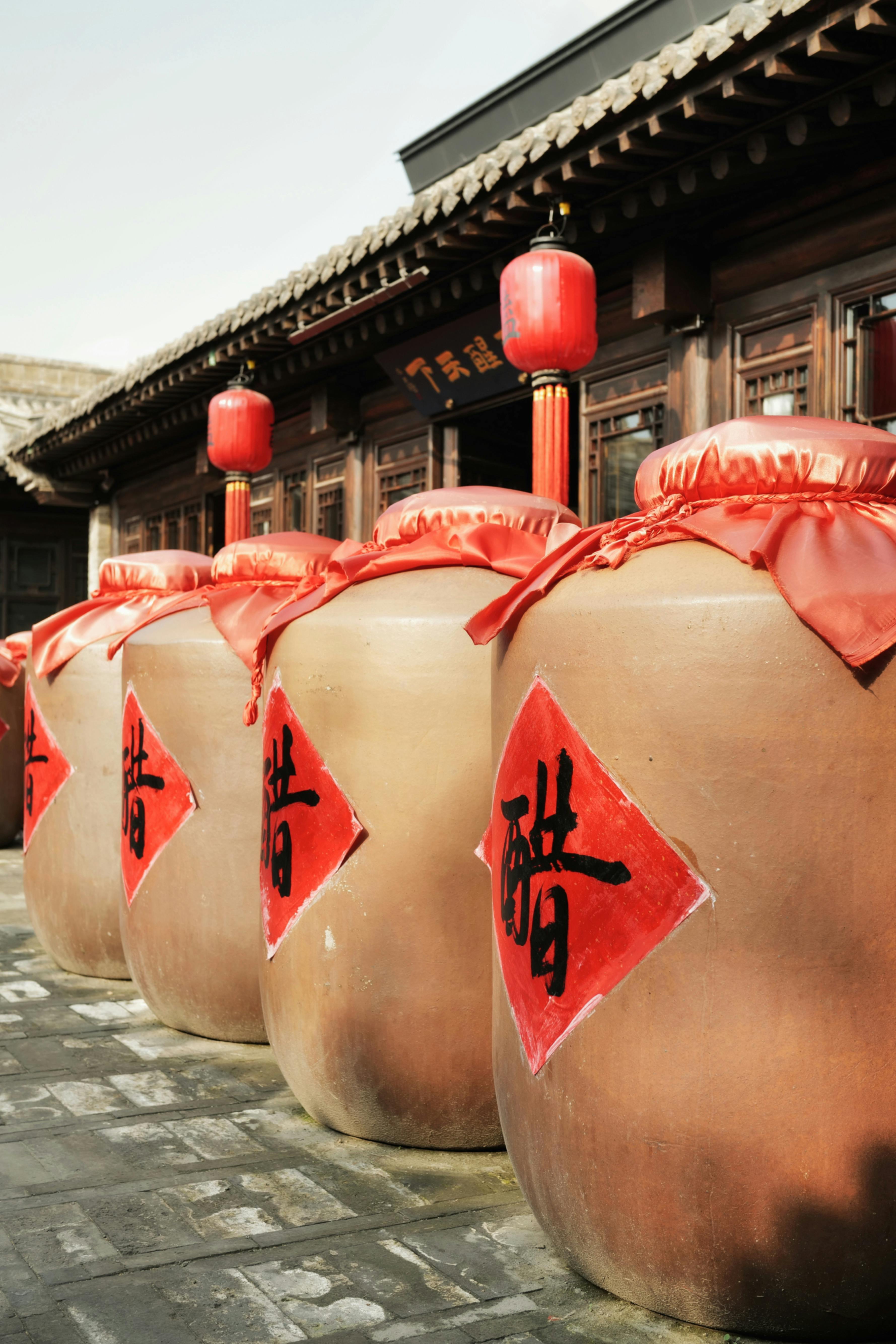 Traditional Chinese Fermentation Jars with Red Seals · Free Stock Photo