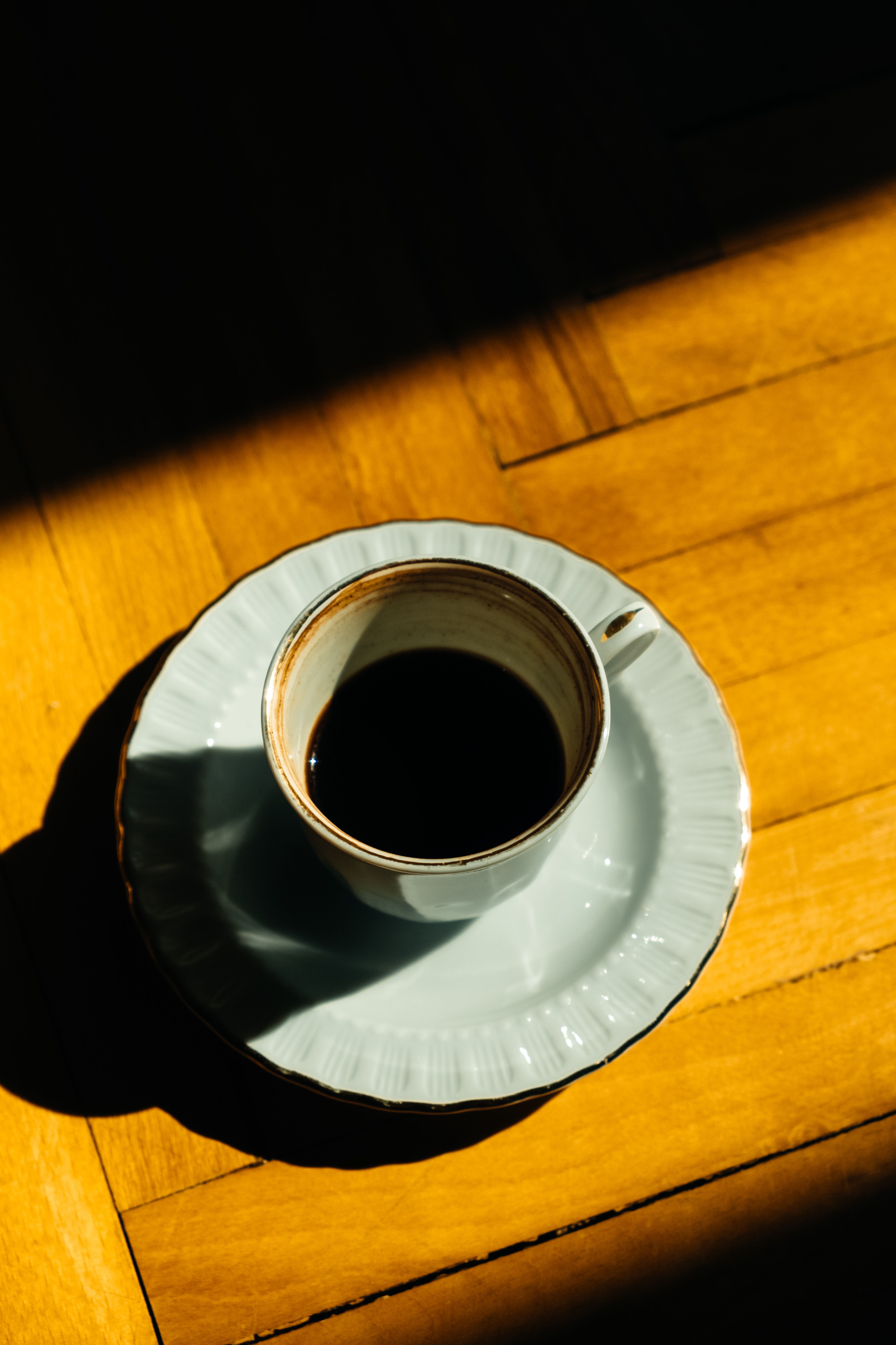 Minimalist Overhead Coffee Cup on Wooden Floor · Free Stock Photo