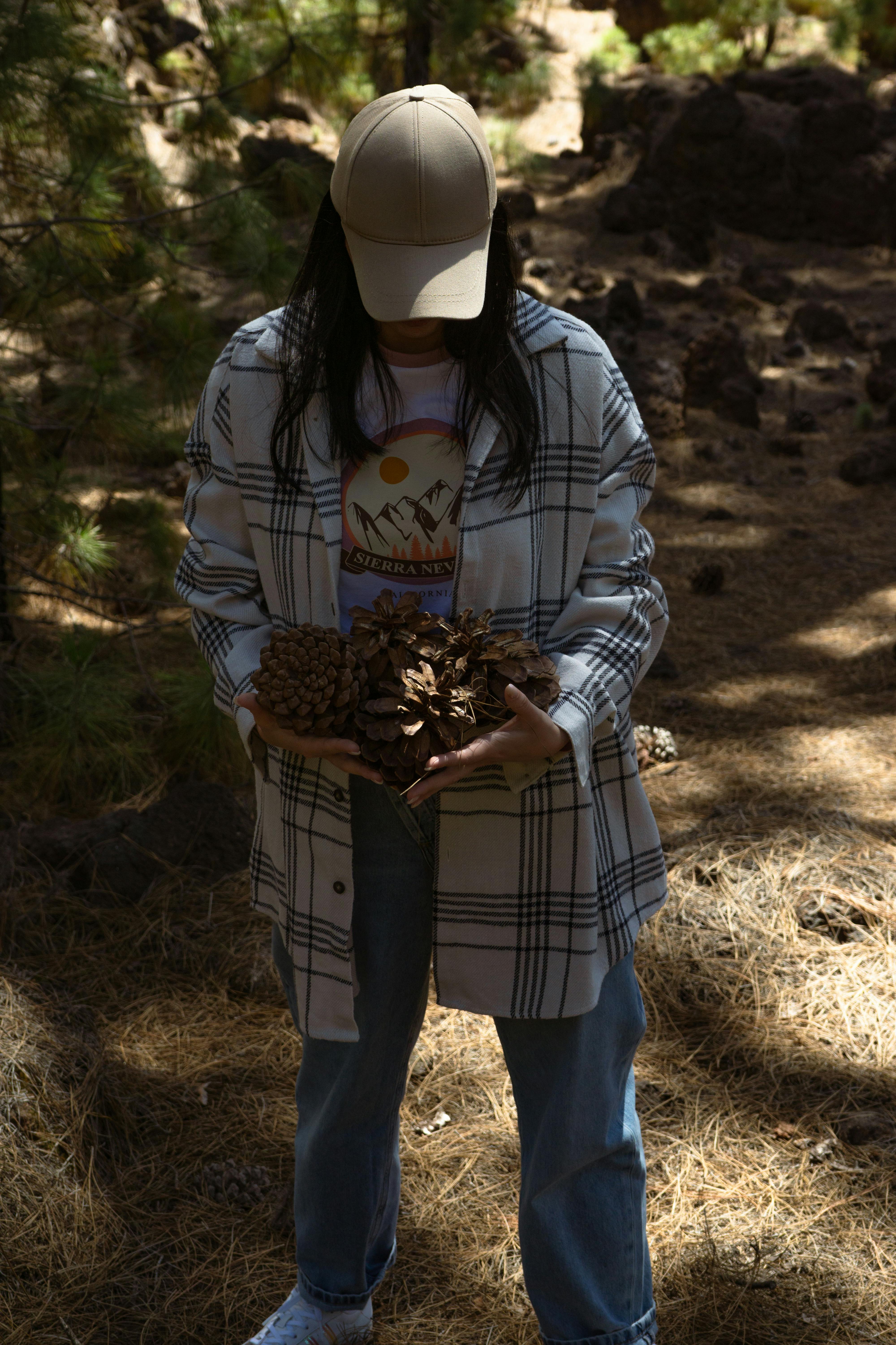 Exploring the Forest: A Woman with Pinecones · Free Stock Photo