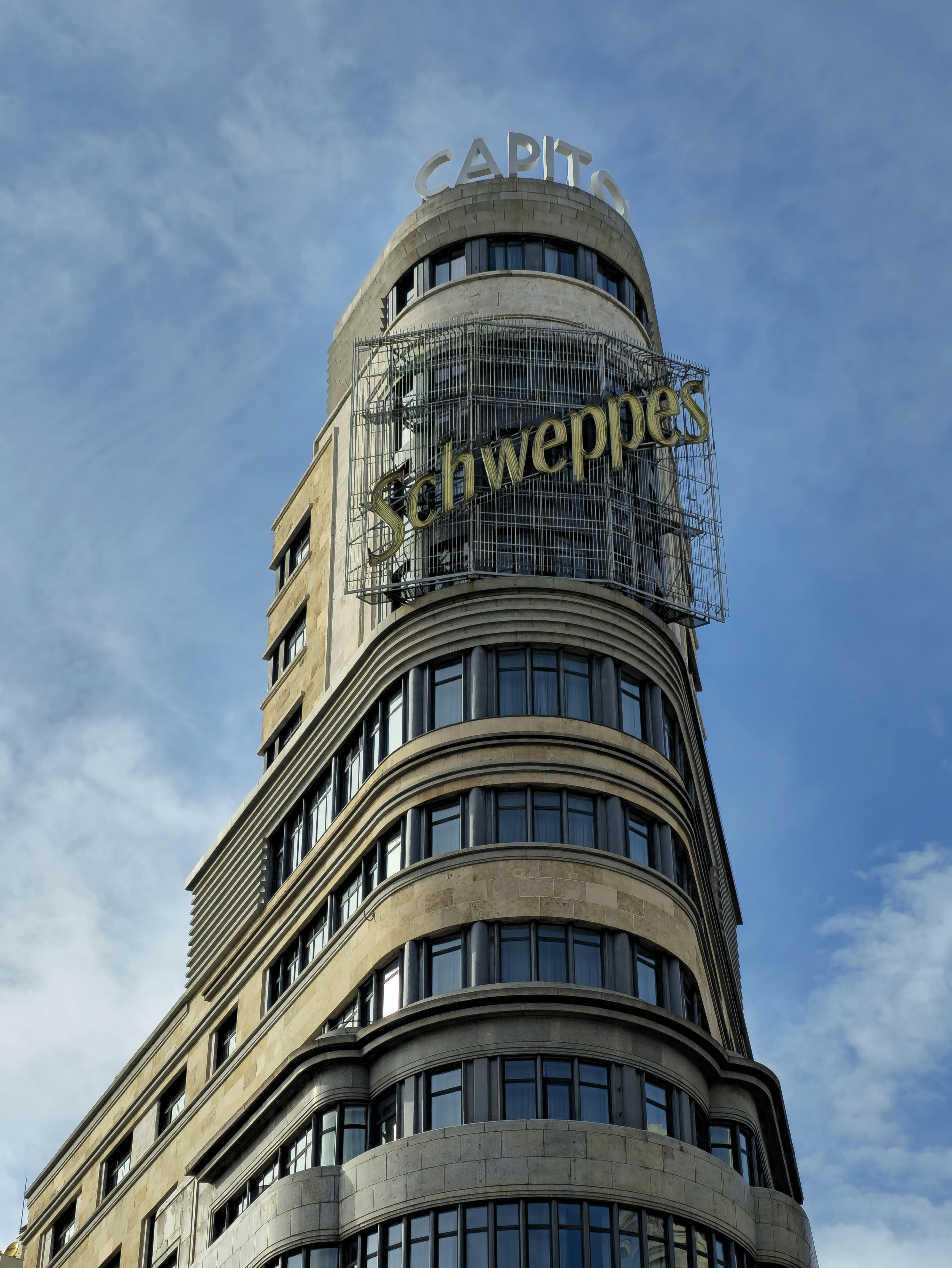 Iconic Capitol Building in Madrid with Schweppes Sign · Free Stock Photo