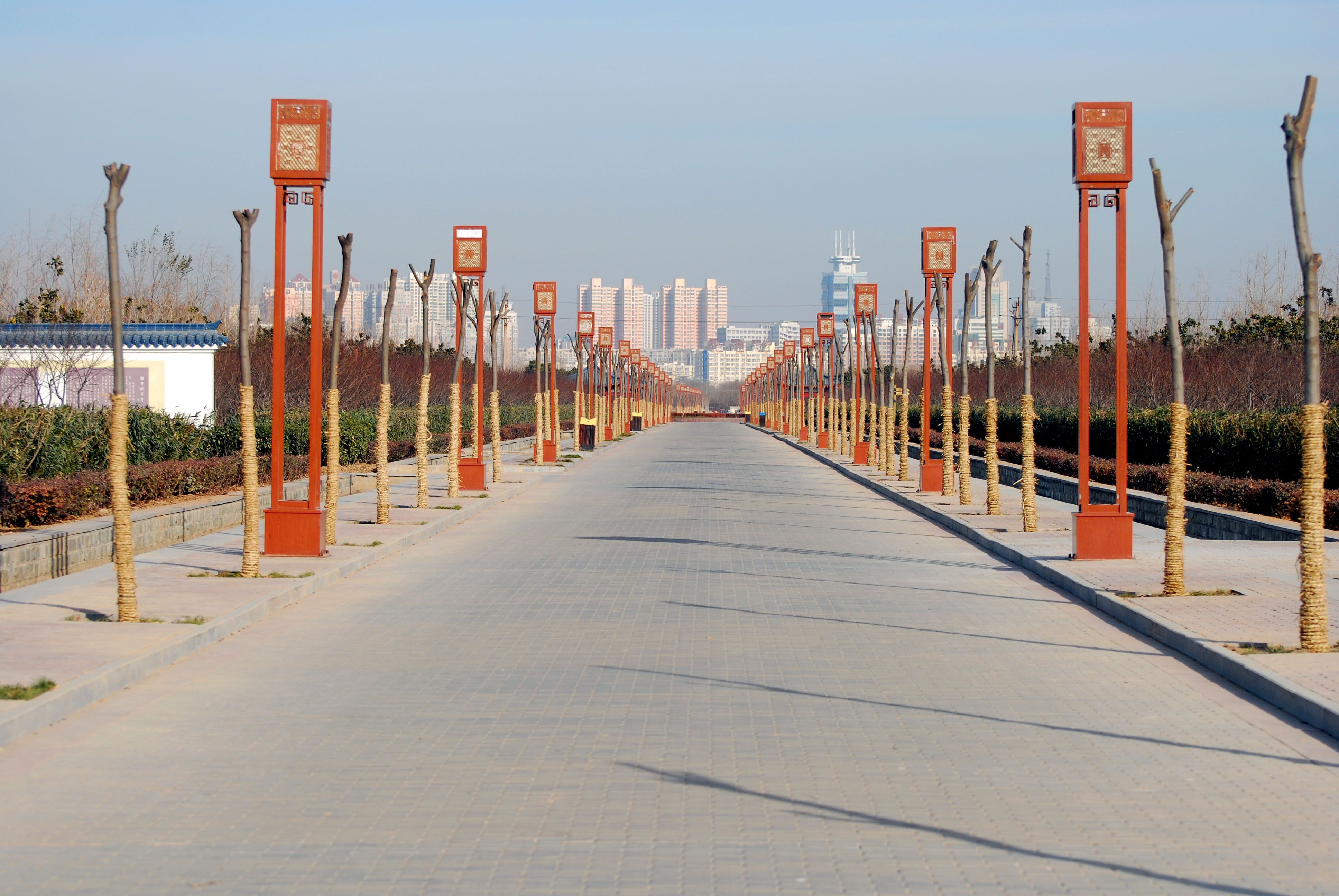 Symmetrical Pathway with Urban Skyline View · Free Stock Photo