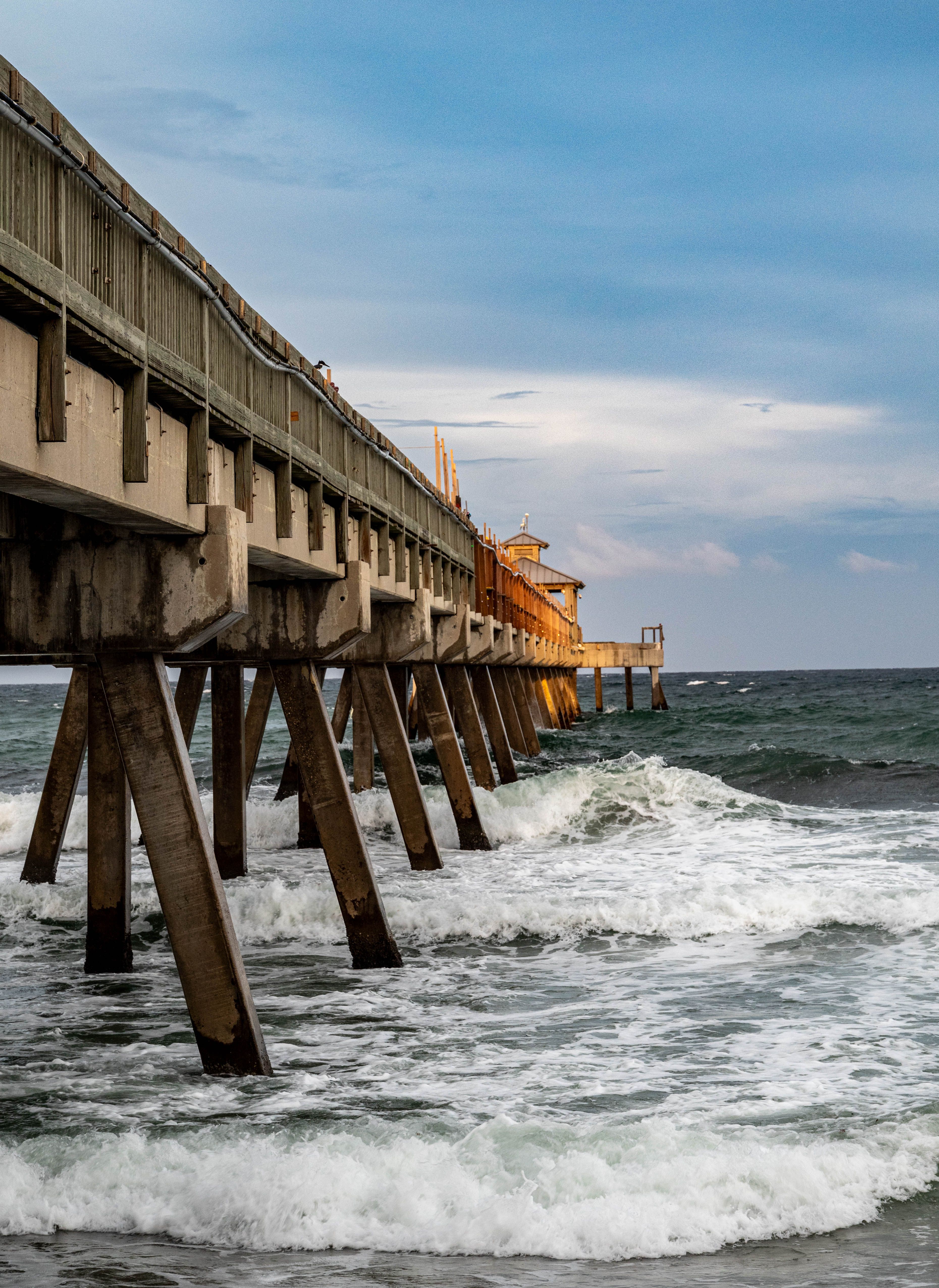 Vibrant Ocean Pier with Waves Crashing · Free Stock Photo