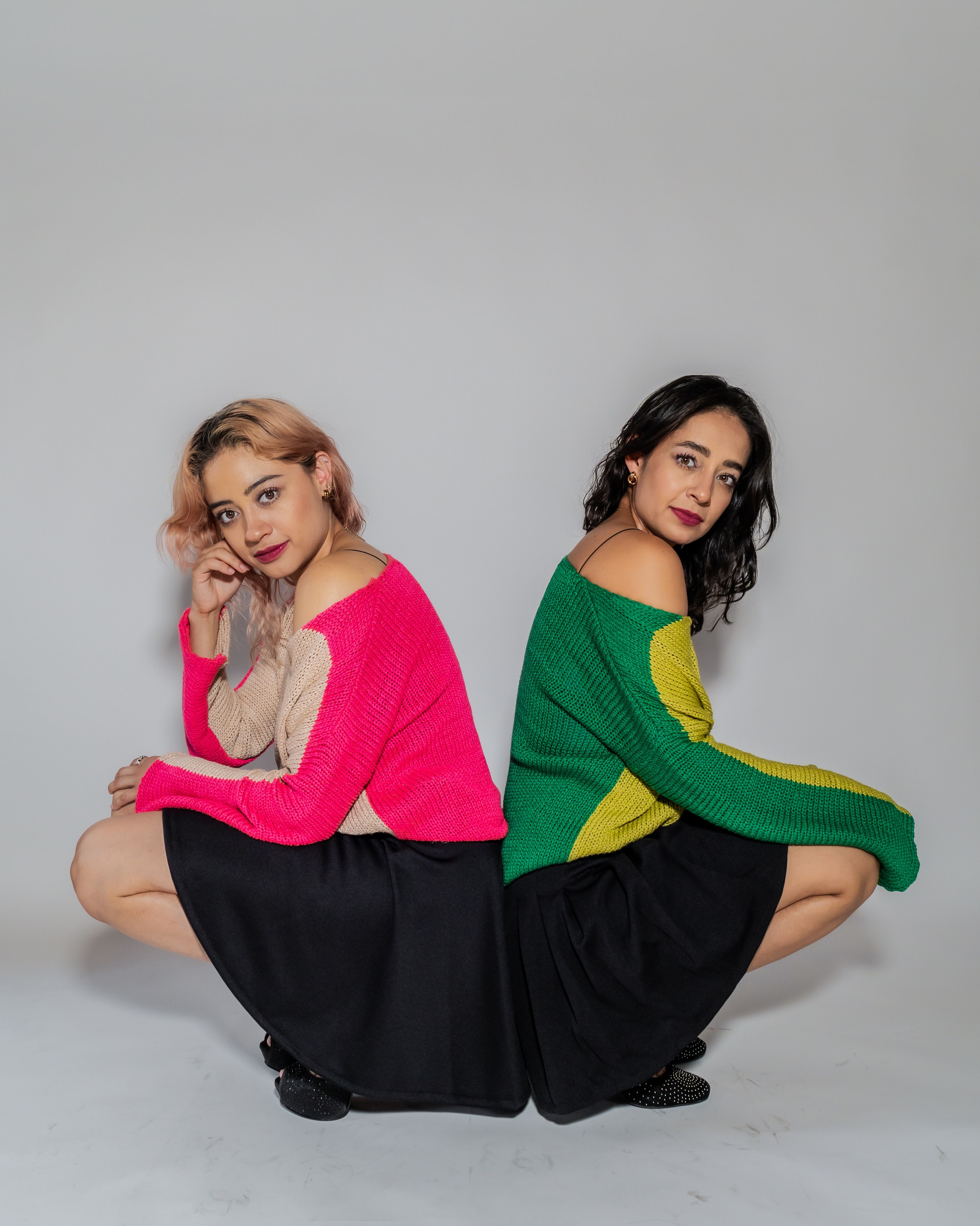 Vibrant Portrait of Two Women in Colorful Sweaters · Free Stock Photo