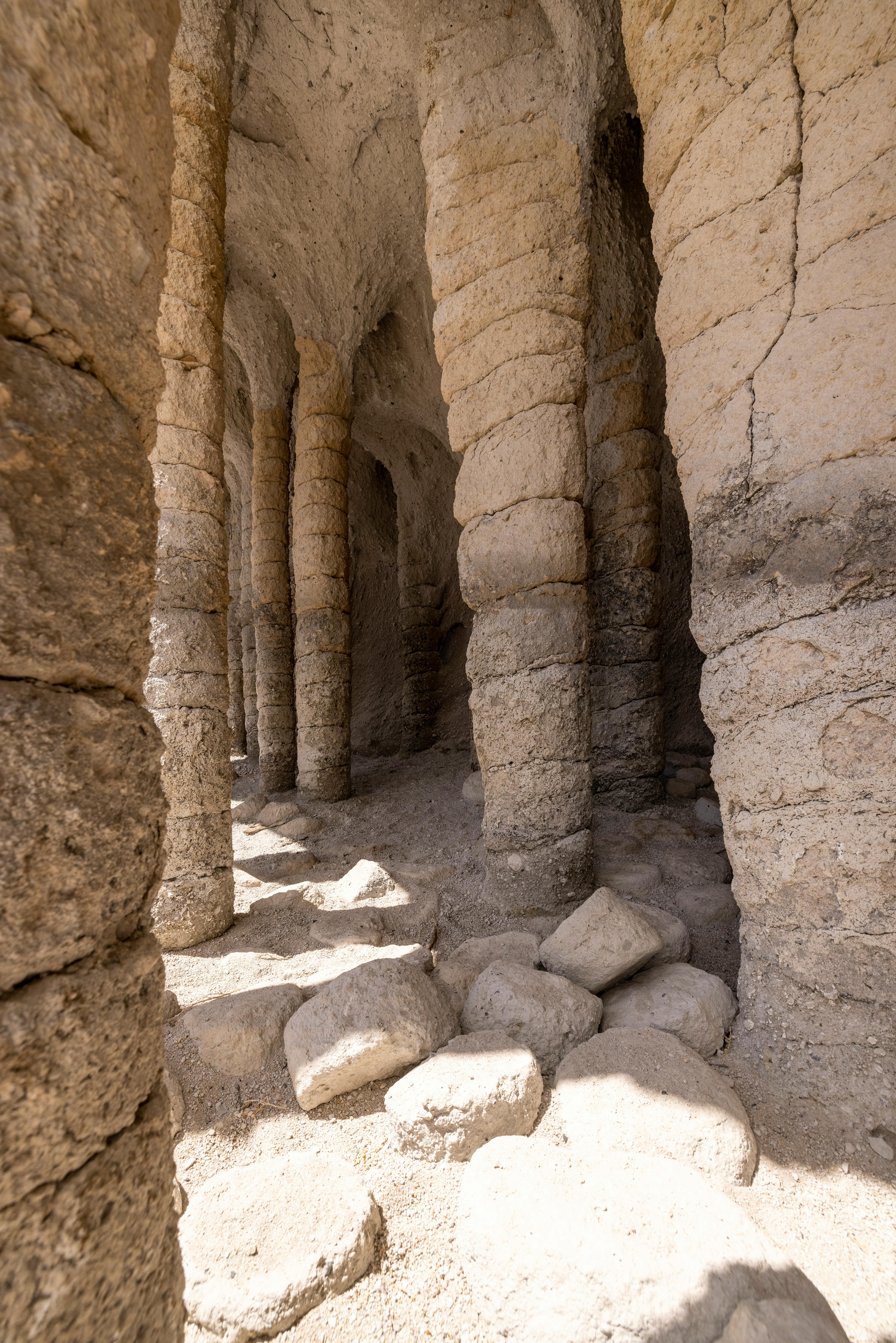 Ancient Stone Columns in Sunlit Cave · Free Stock Photo