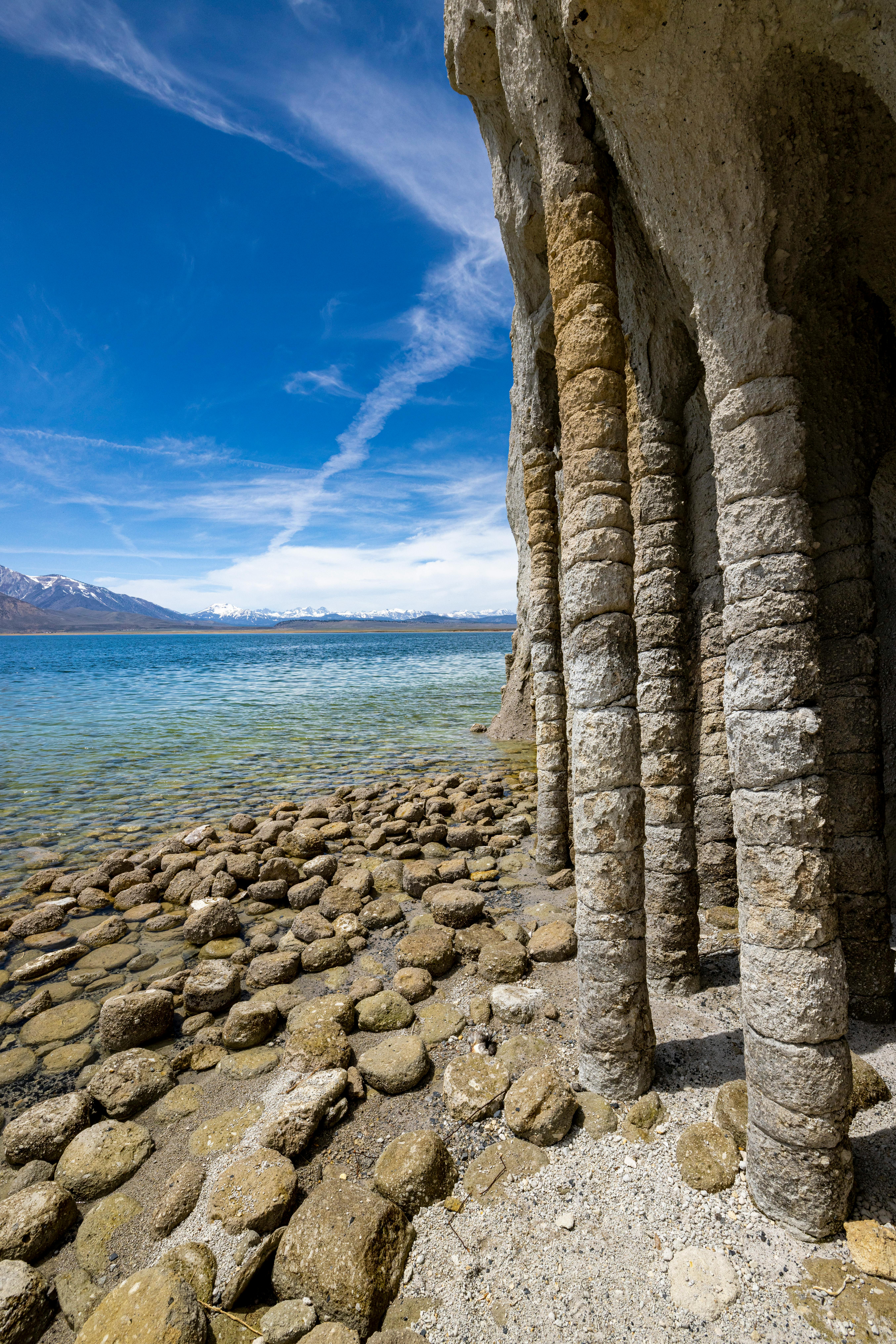 Natural Stone Columns by Clear Blue Lake · Free Stock Photo