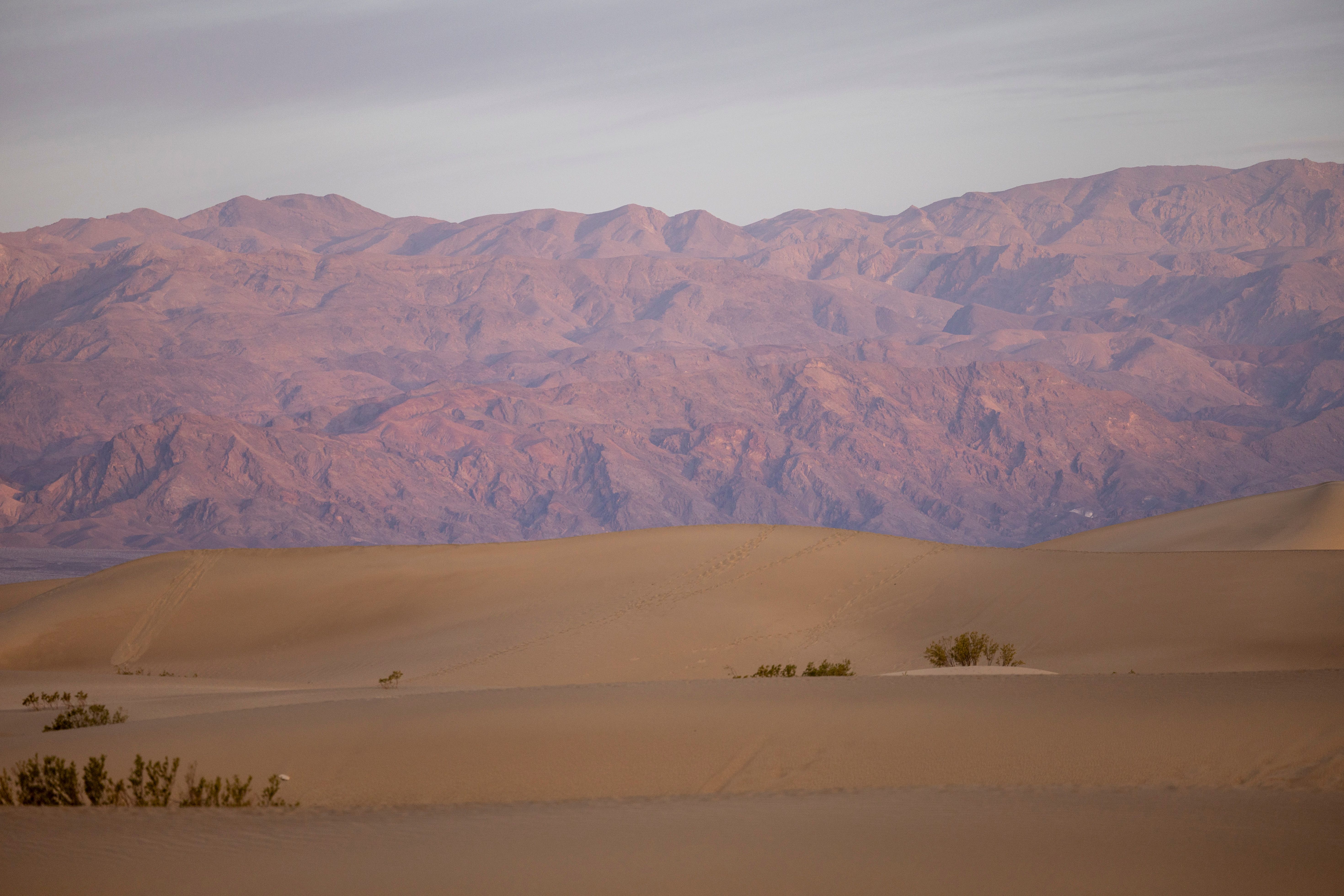 Stunning Mountain Range and Desert Dunes at Sunset · Free Stock Photo