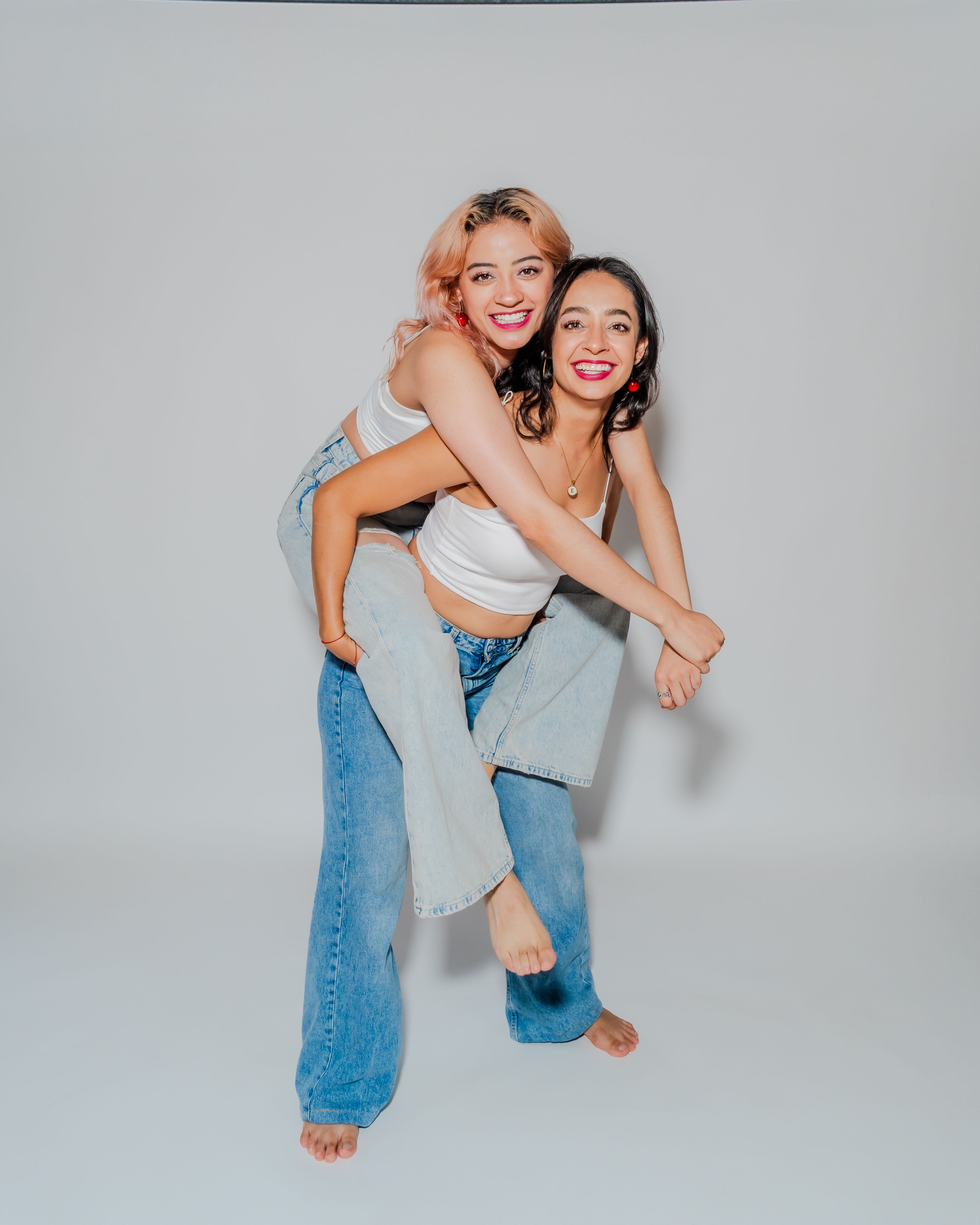 Joyful Friends Embracing in Studio Portrait · Free Stock Photo
