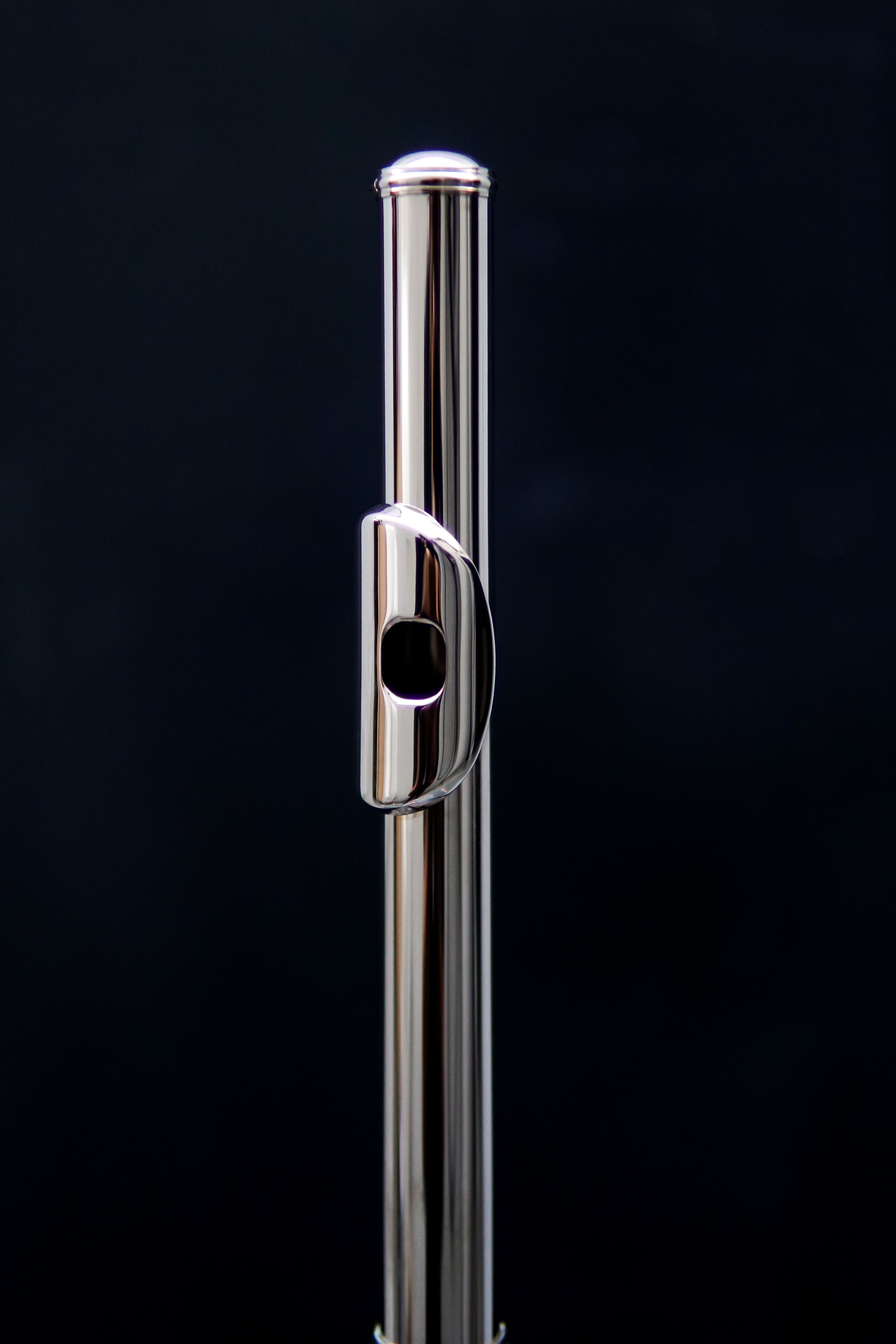 Elegantly Designed Metal Flute on Dark Background · Free Stock Photo