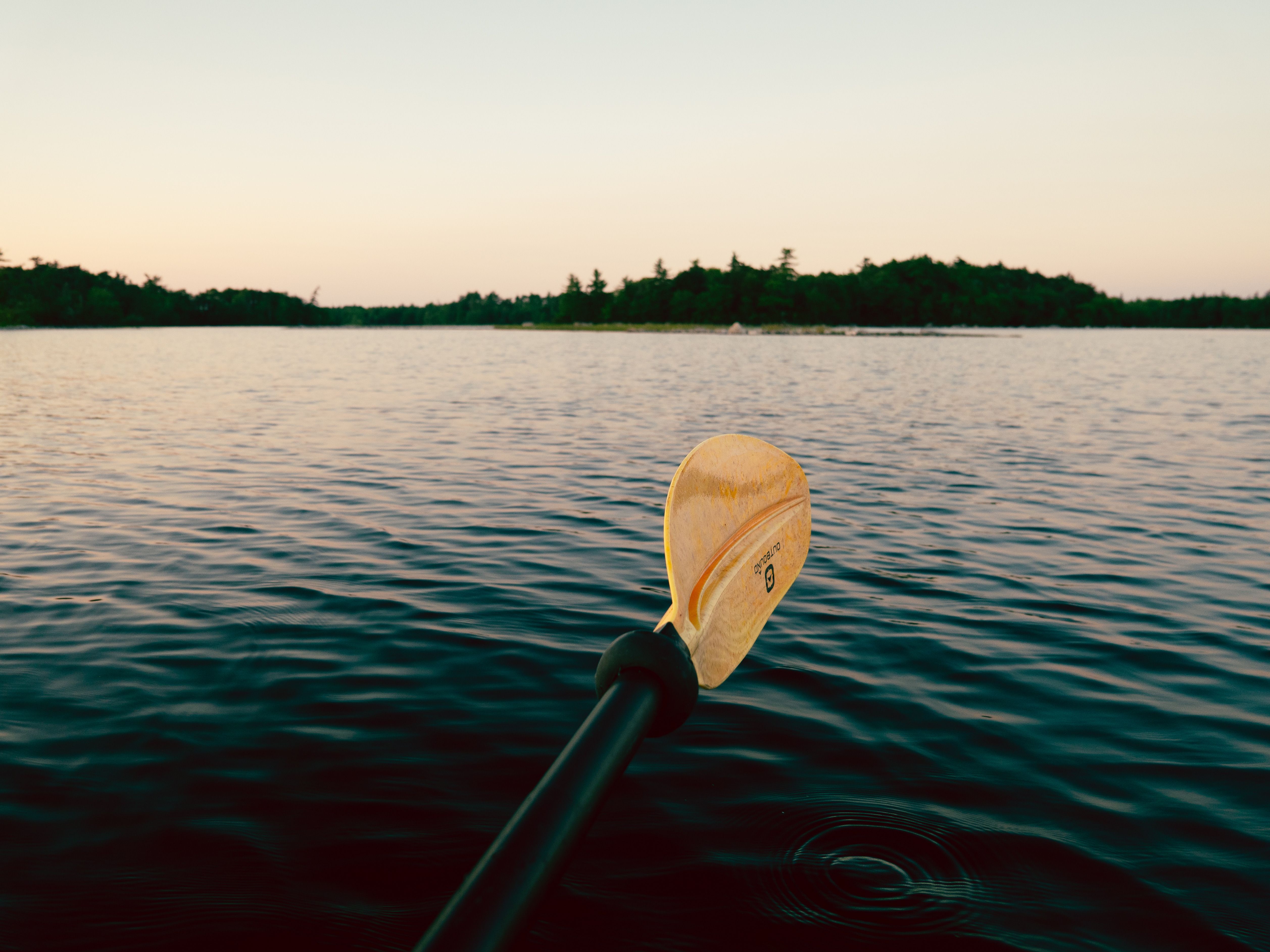 Peaceful evening kayaking on calm lake · Free Stock Photo