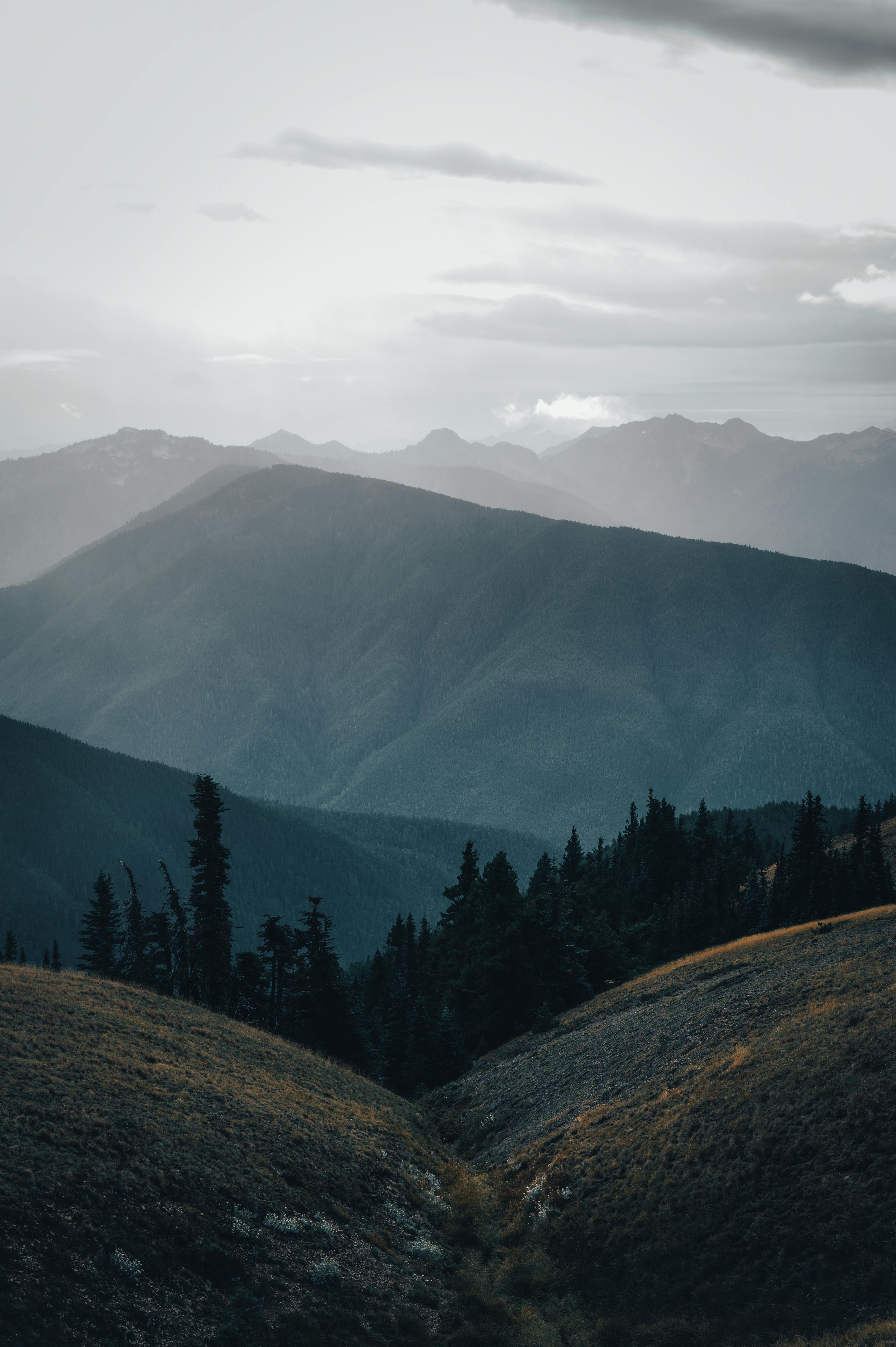 Majestic Mountain Range Under Cloudy Sky · Free Stock Photo