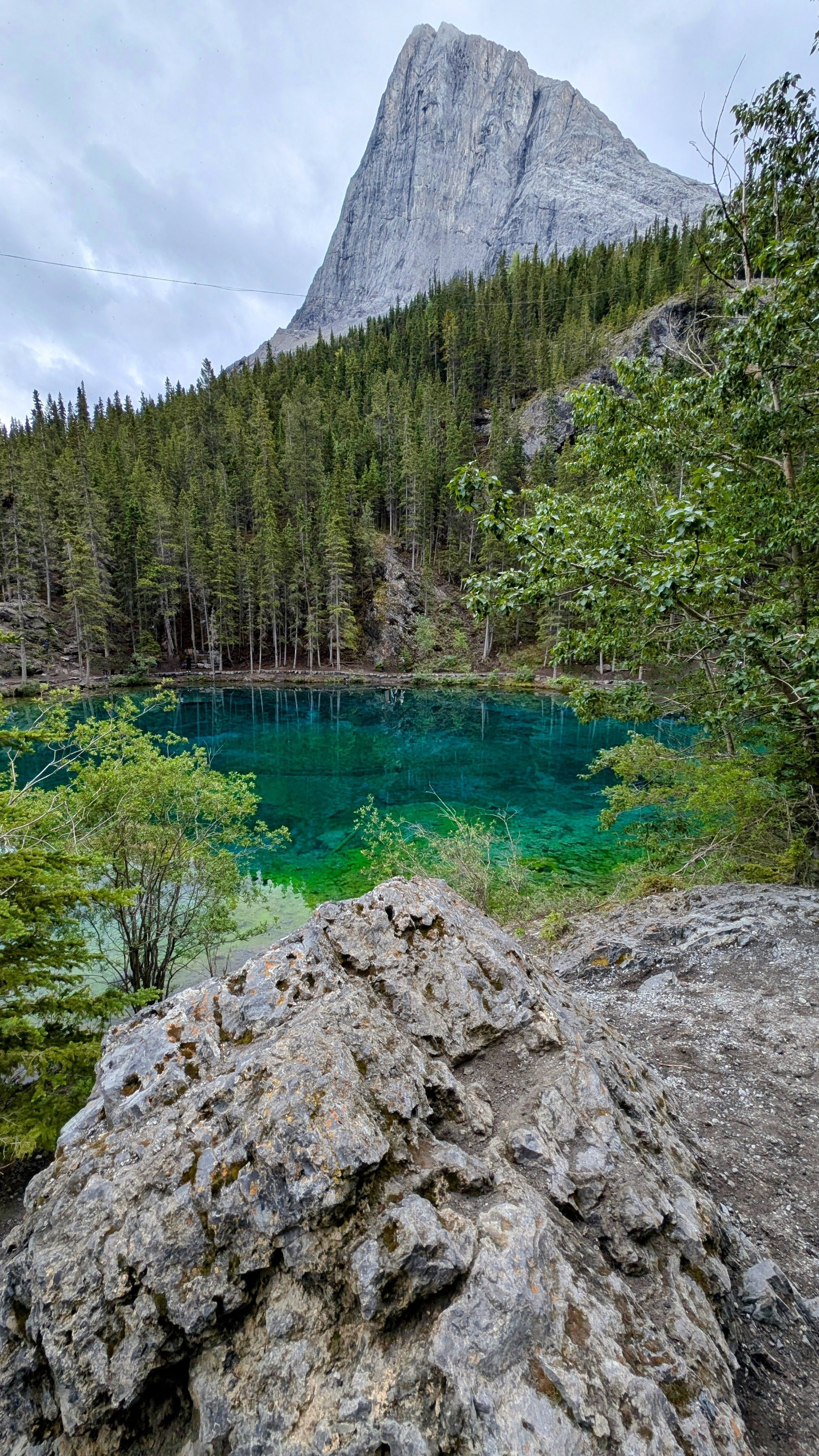 Serene Lake Amidst Rocky Mountains in Canmore · Free Stock Photo