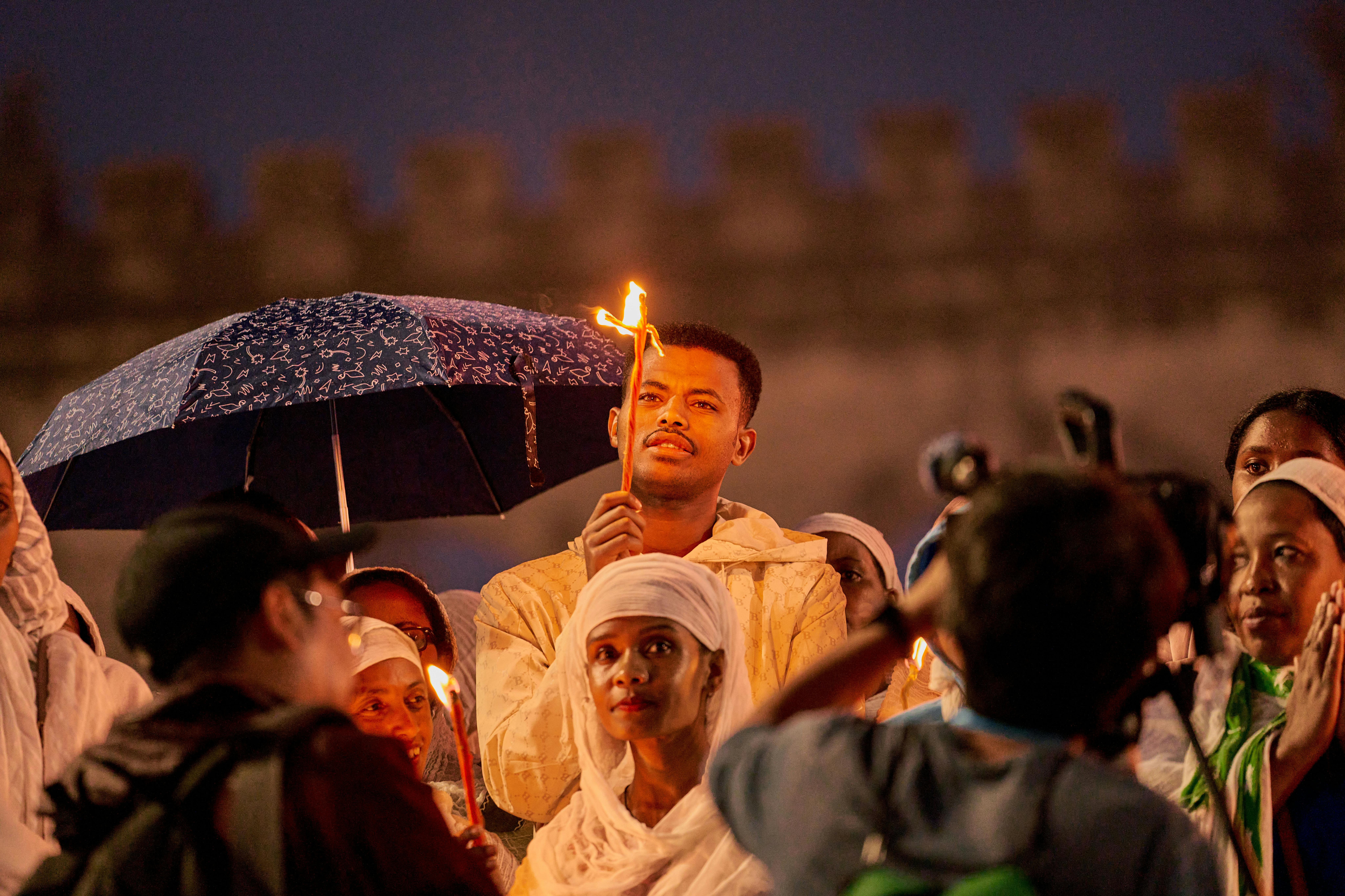 Candlelight Vigil in Traditional Ethiopian Attire · Free Stock Photo