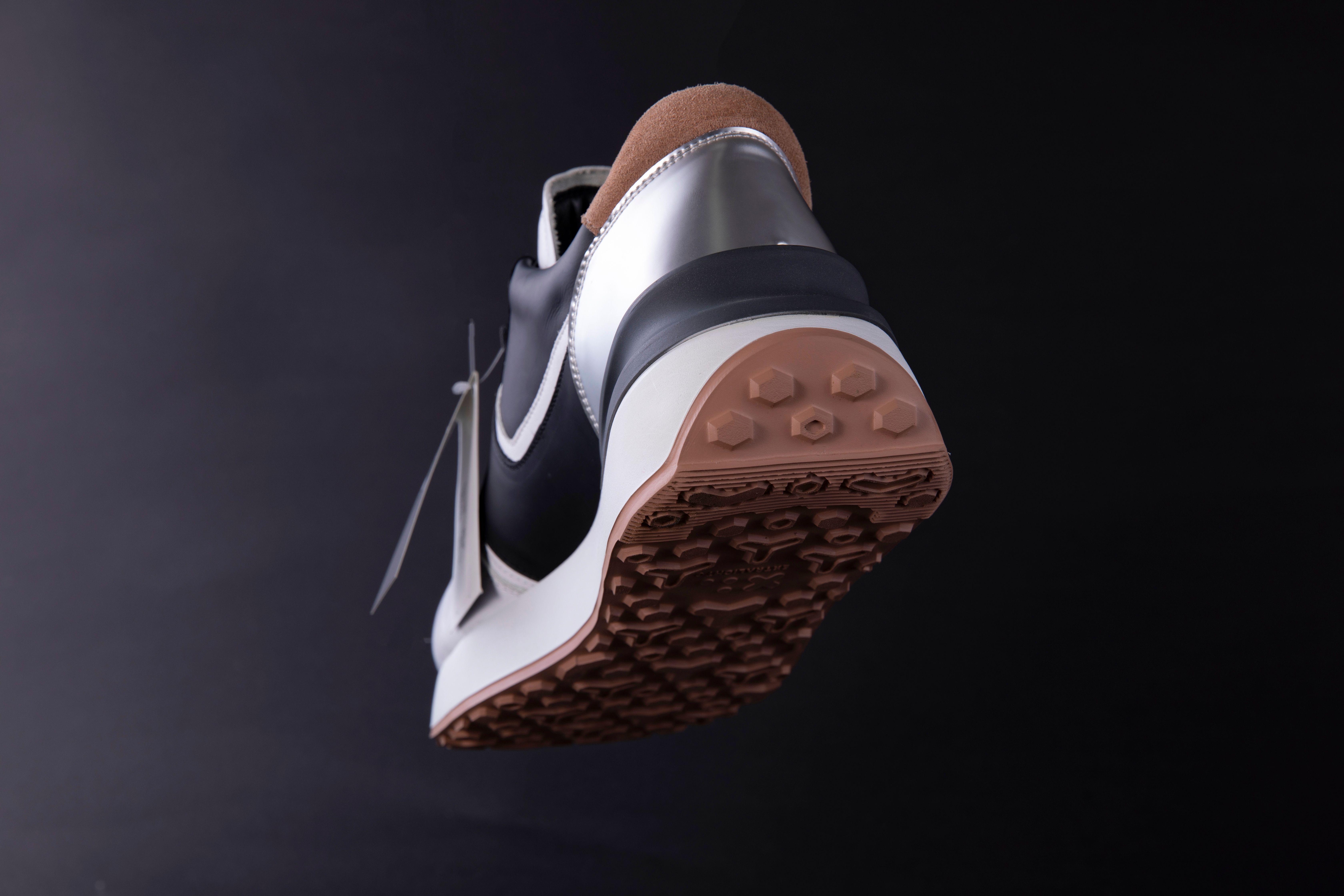 Close-up of Athletic Shoe Sole Against Black Background · Free Stock Photo