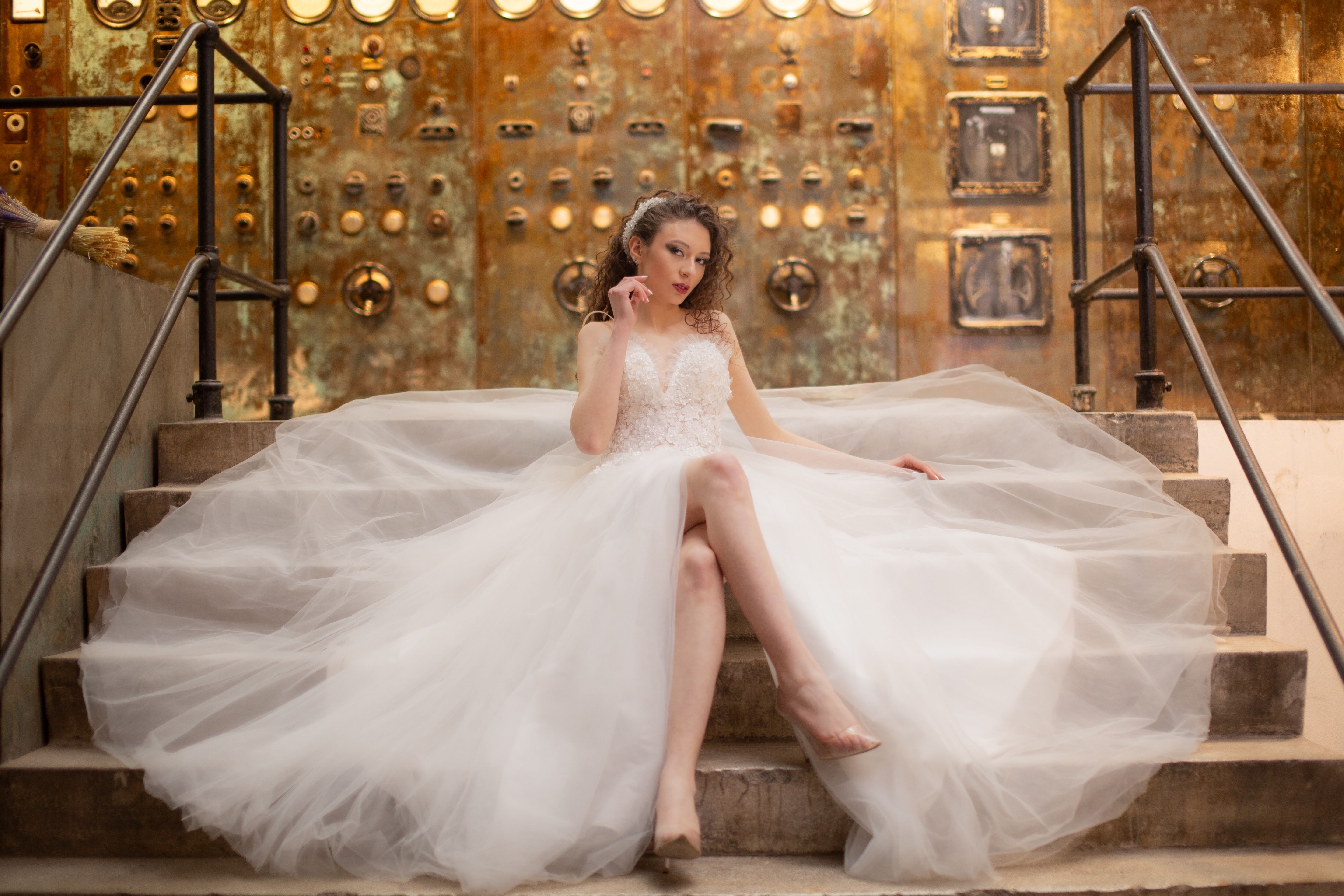 Elegant Bride in Industrial Setting on Staircase · Free Stock Photo