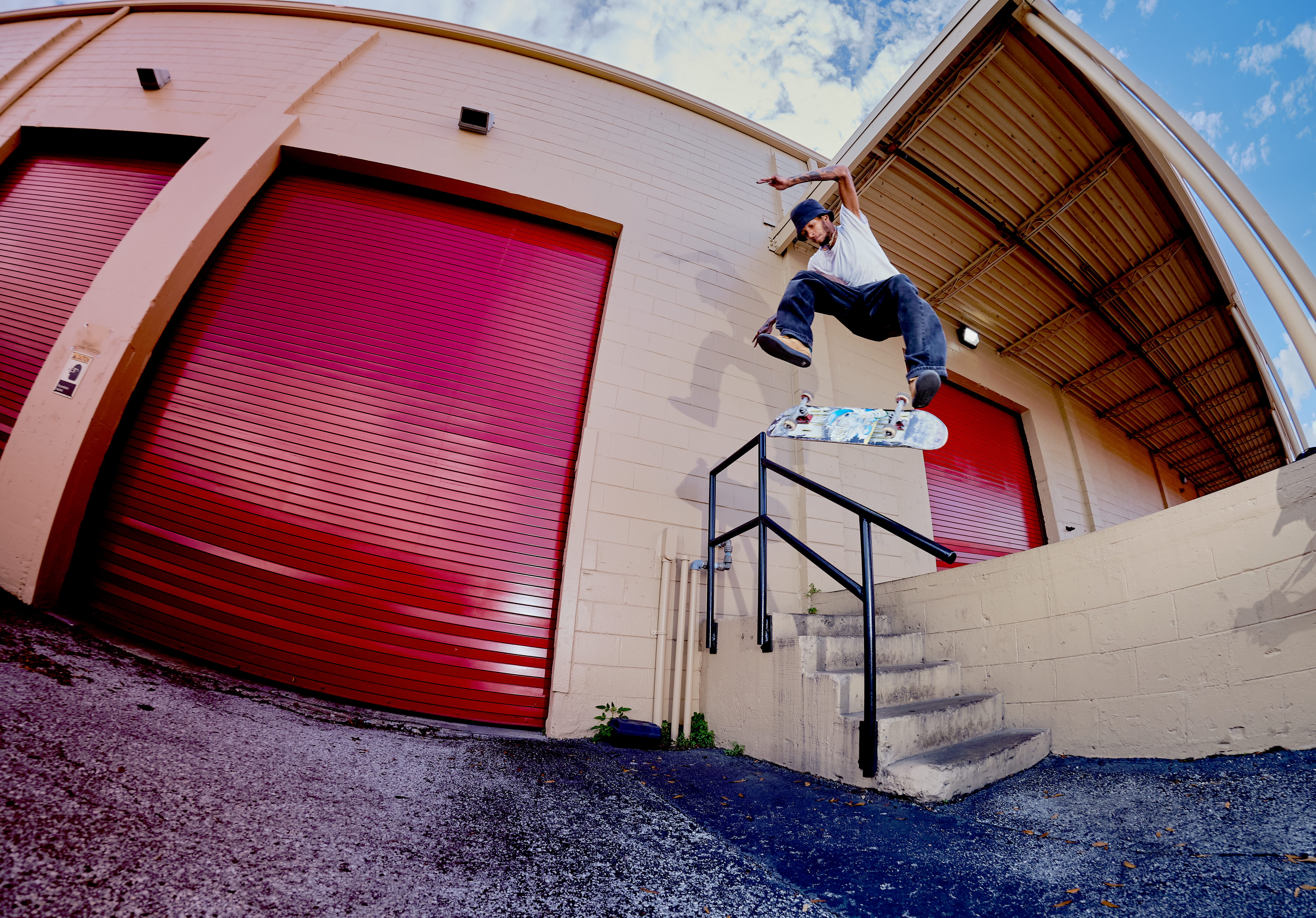 Dynamic Skateboarding Trick at Urban Warehouse · Free Stock Photo