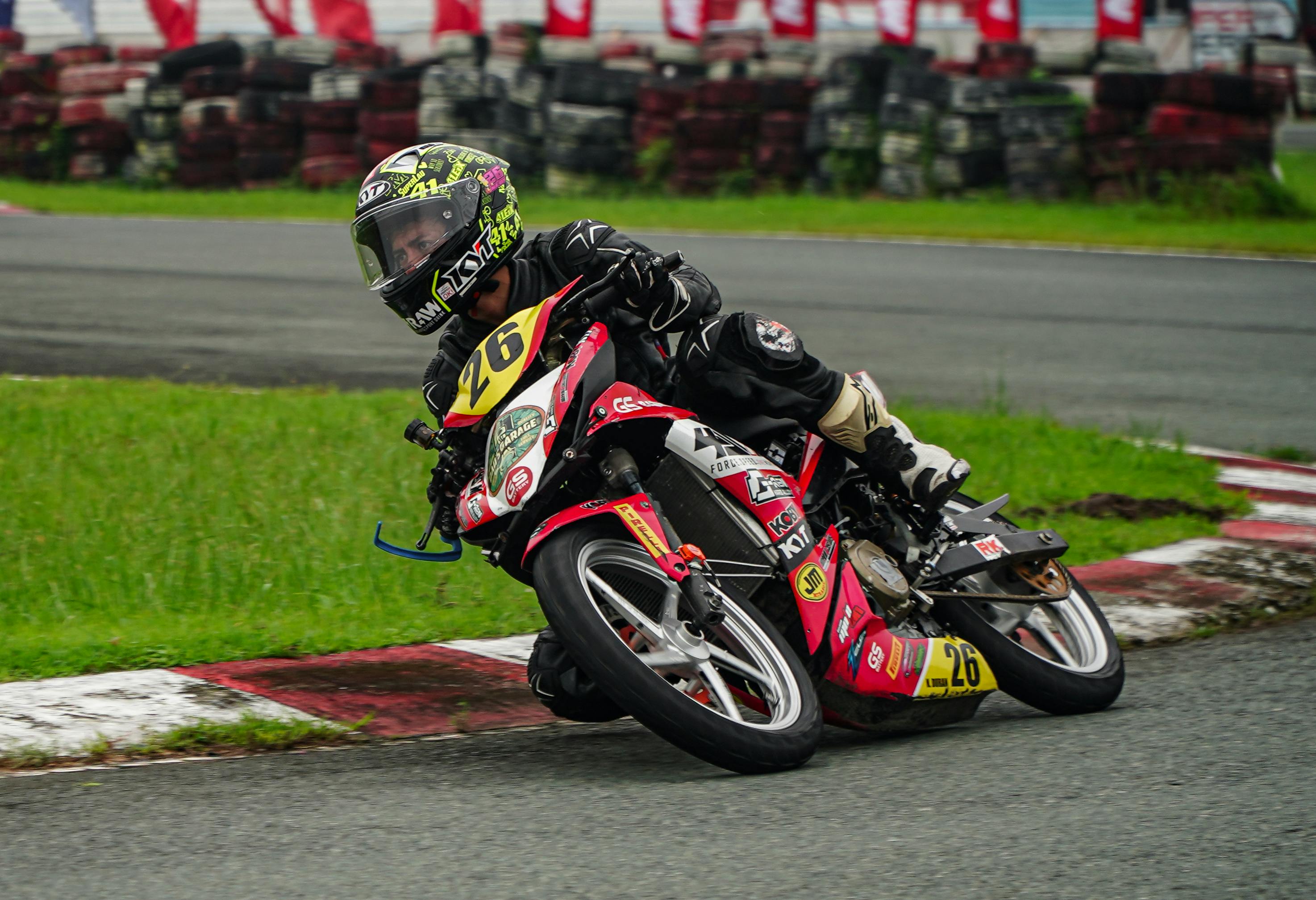 A Racer Riding His Motorcycle in the Race Track · Free Stock Photo